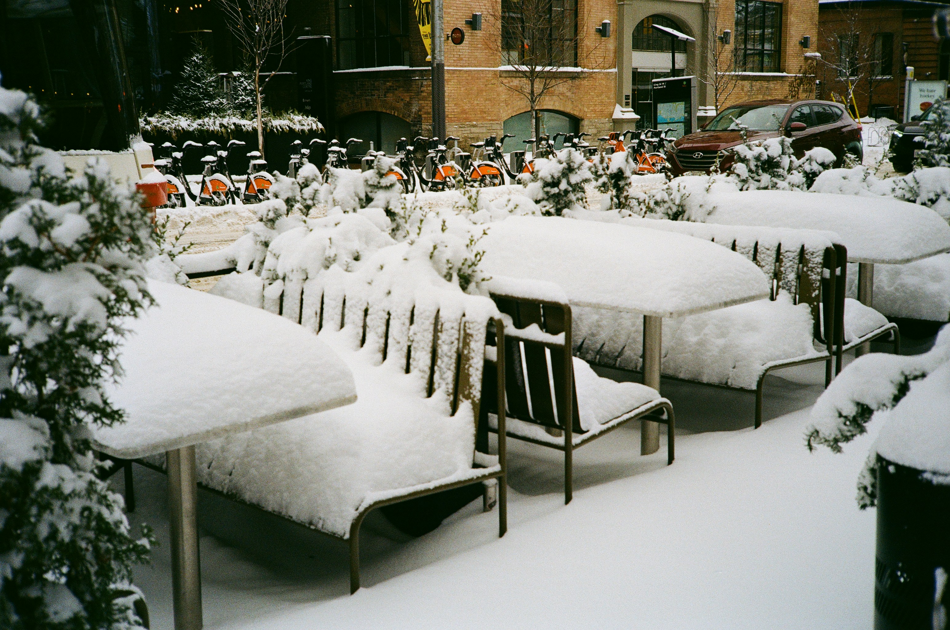 Outdoor cafe tables and chairs covered in snow photo – Free Canada ...