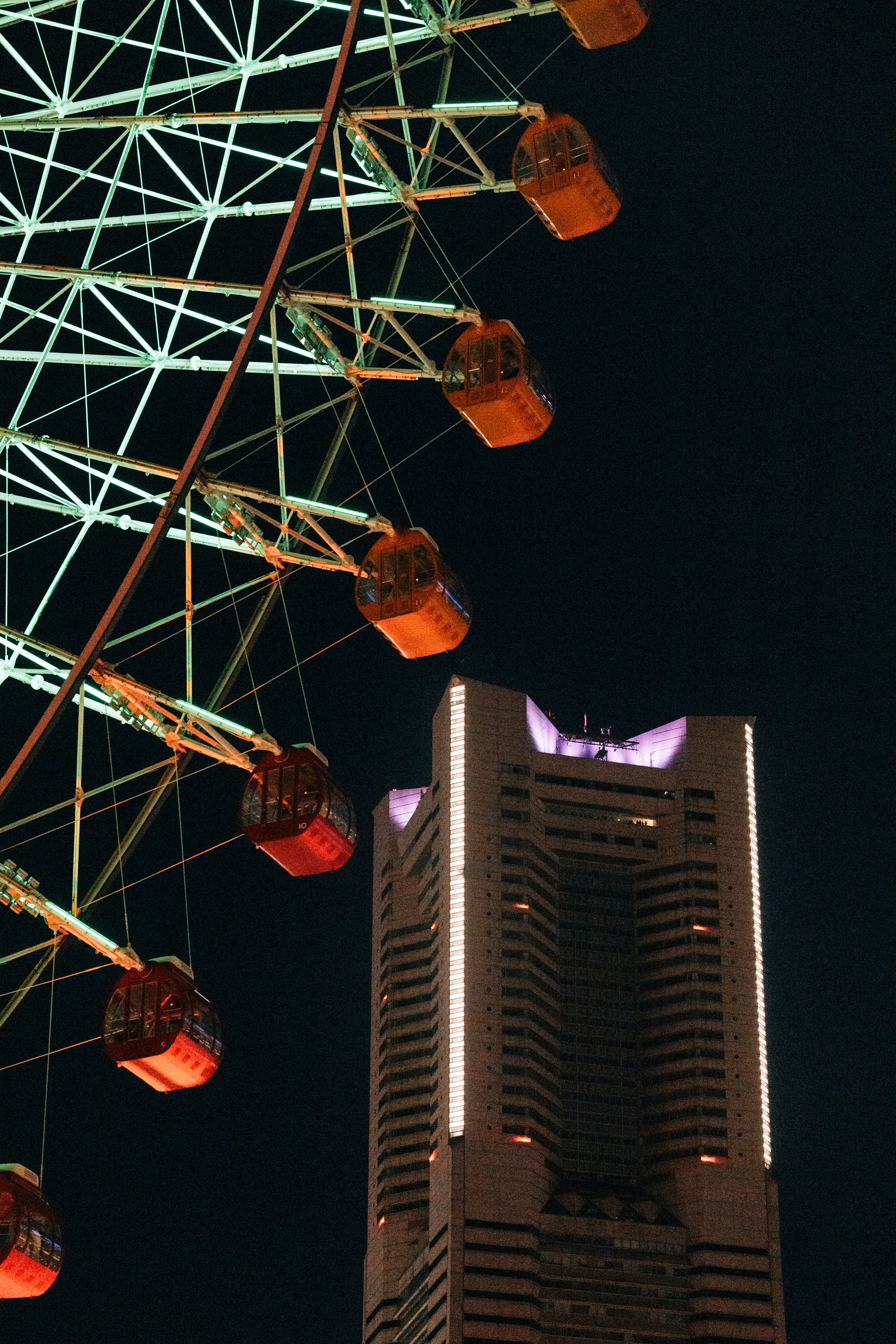 Ferris wheel and illuminated skyscraper at night. photo – Free Building ...