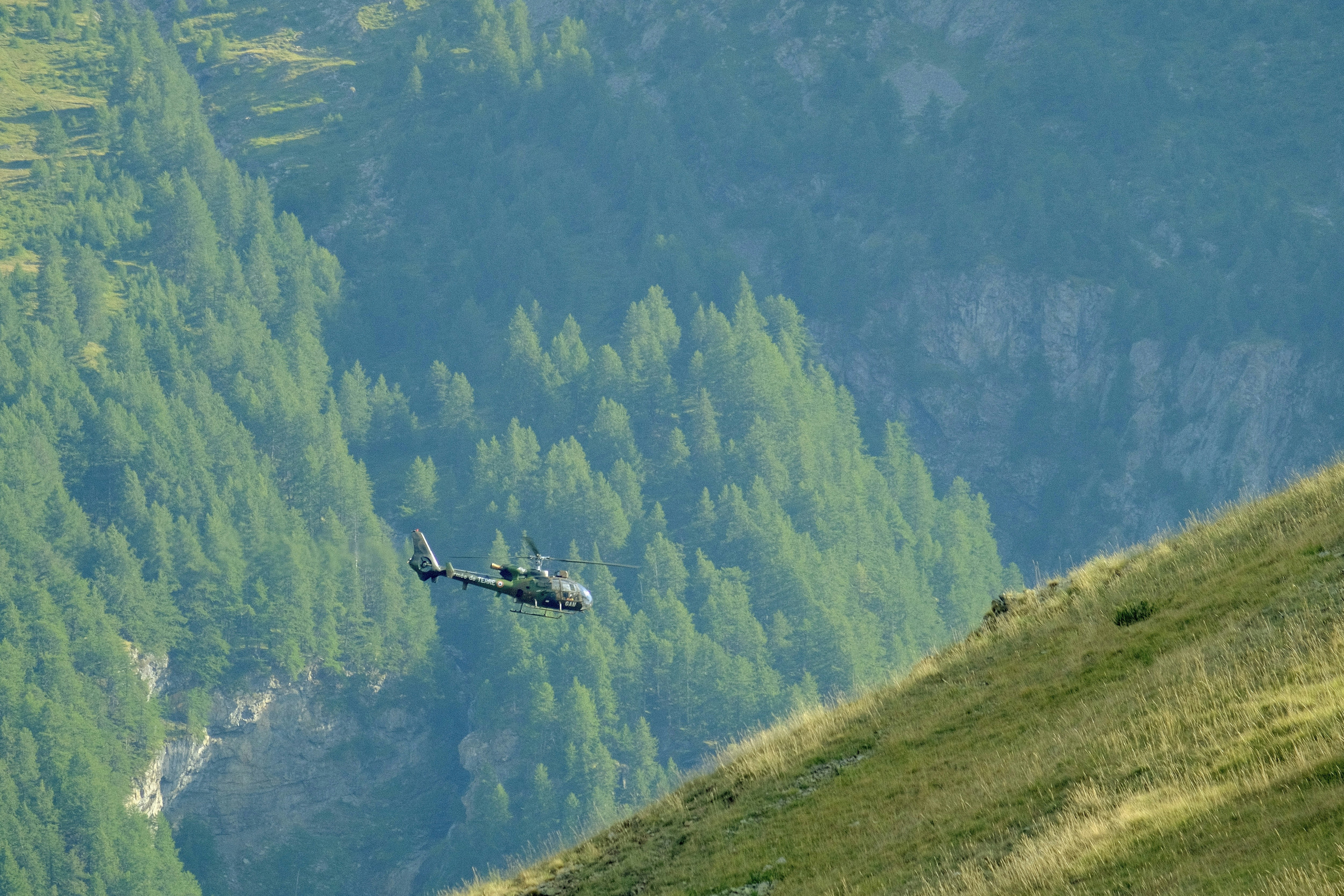 Aerial Serenity: The Helicopter's Journey Through Verdant Peaks