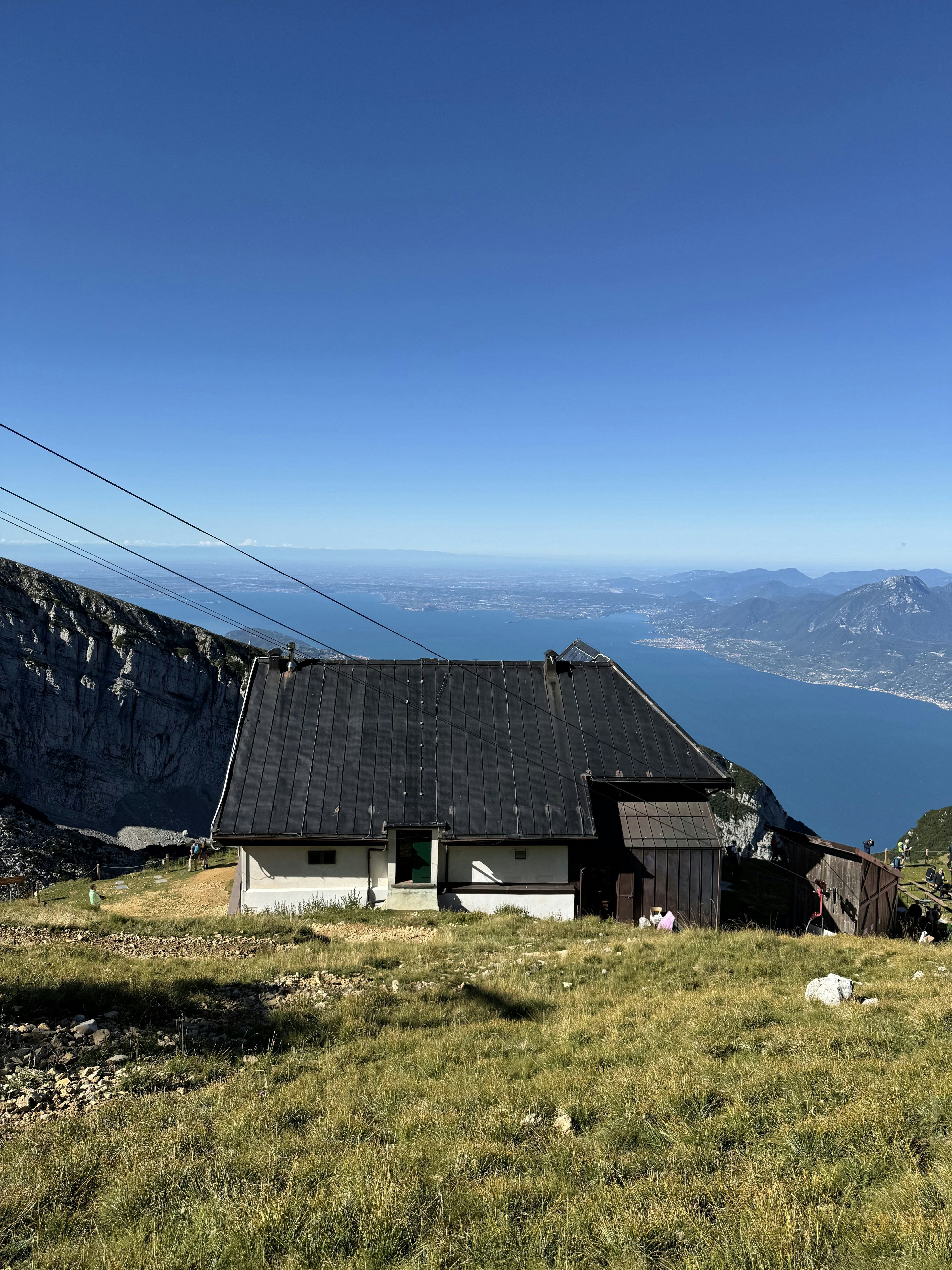 Alpine Cabin Clinging to the Slope Under a Wide Azure Sky