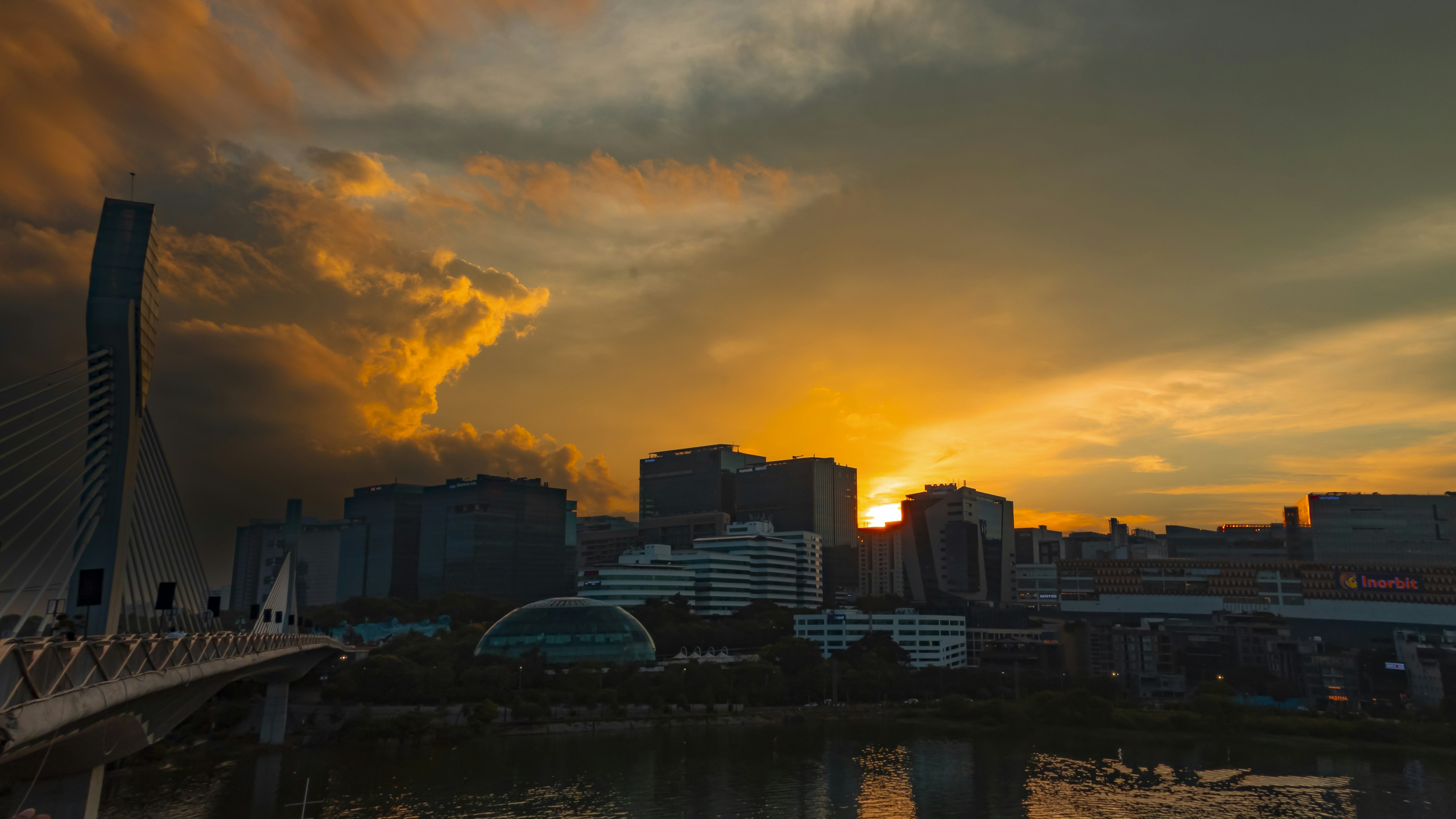 City skyline at sunset with dramatic clouds
