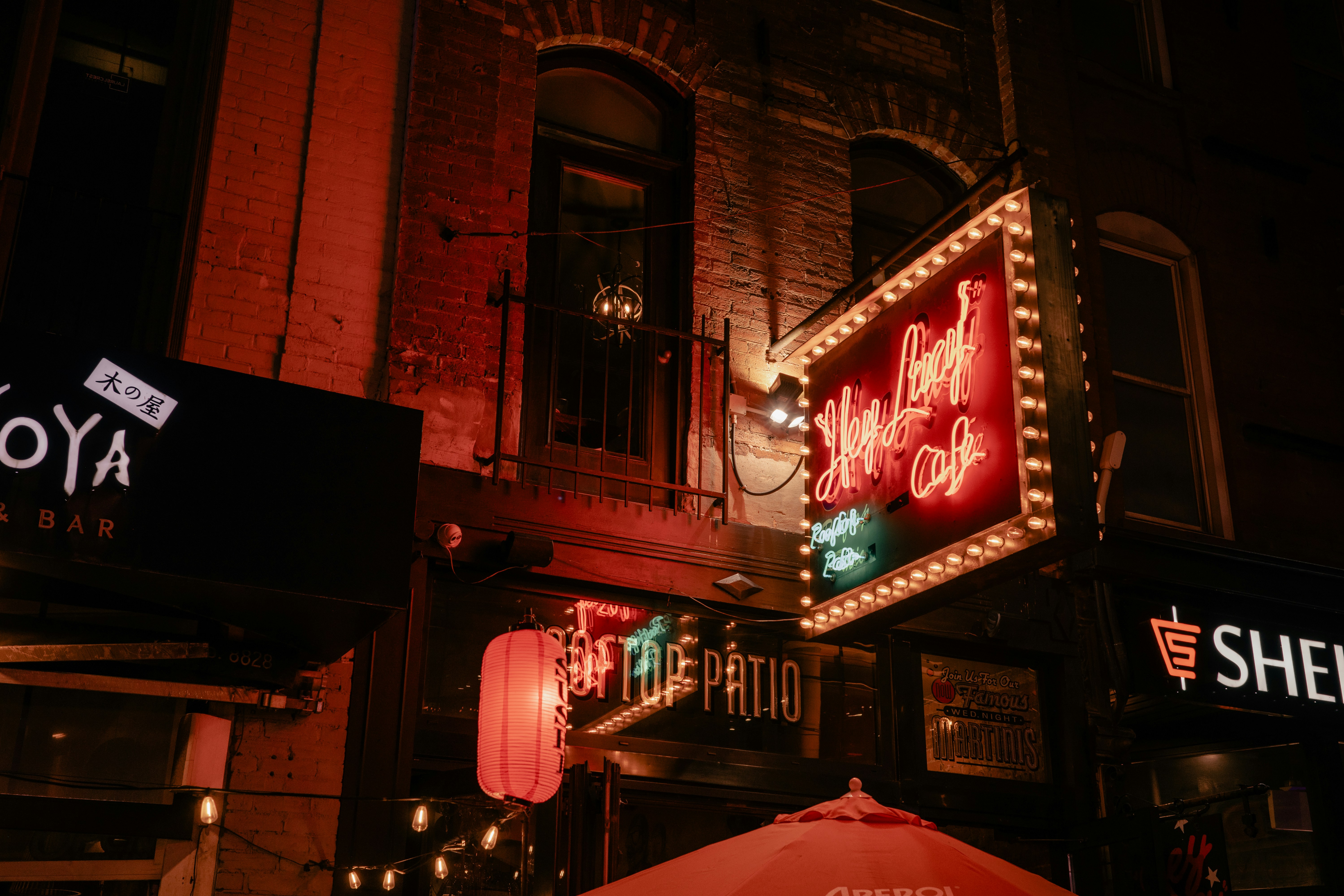 /neon-signs-illuminate-a-cafe-and-bar-at-night | Neon signs illuminate a cafe and bar at night.