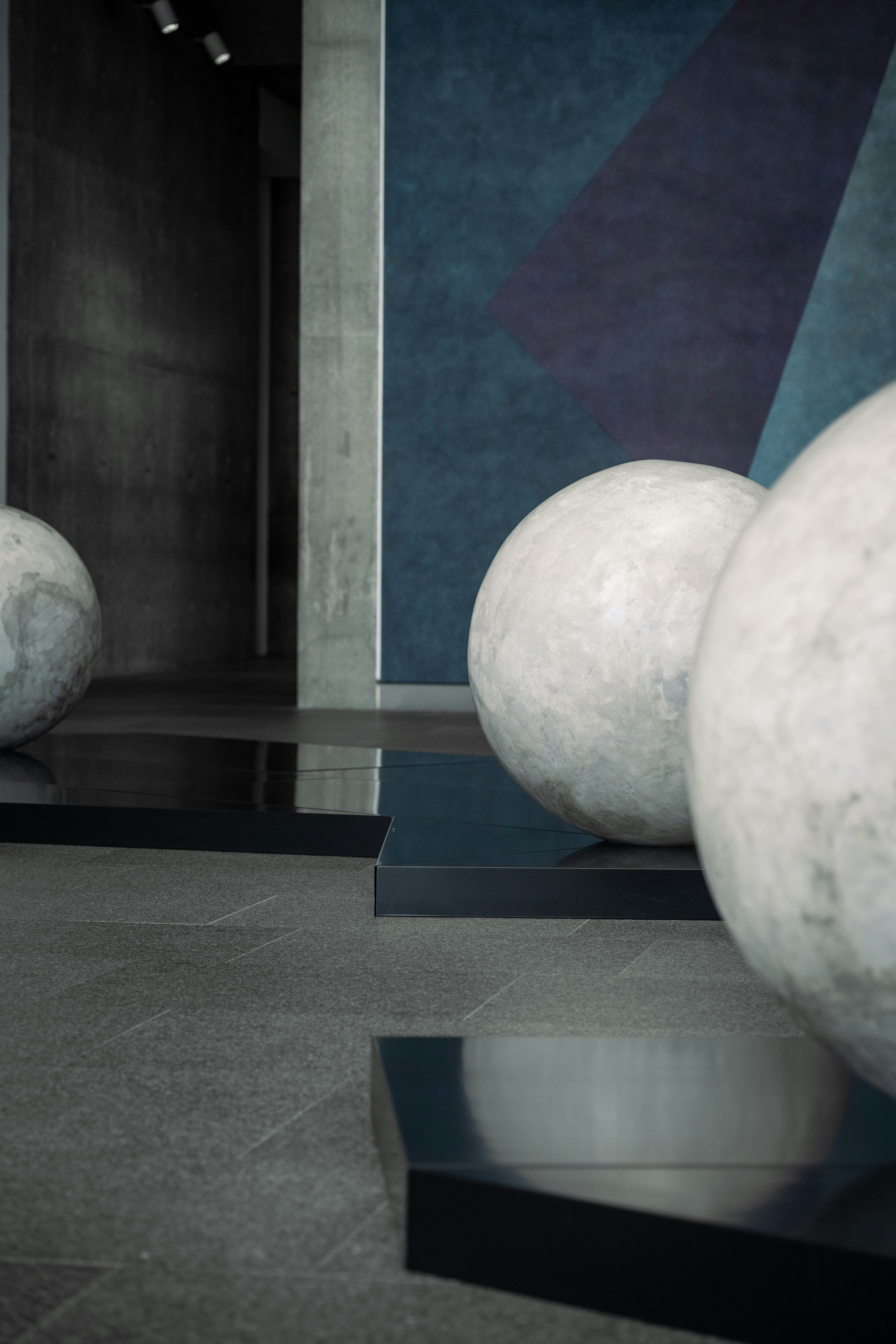 Orbital Quiet: Concrete Spheres, Reflections, and a Geometric Atrium