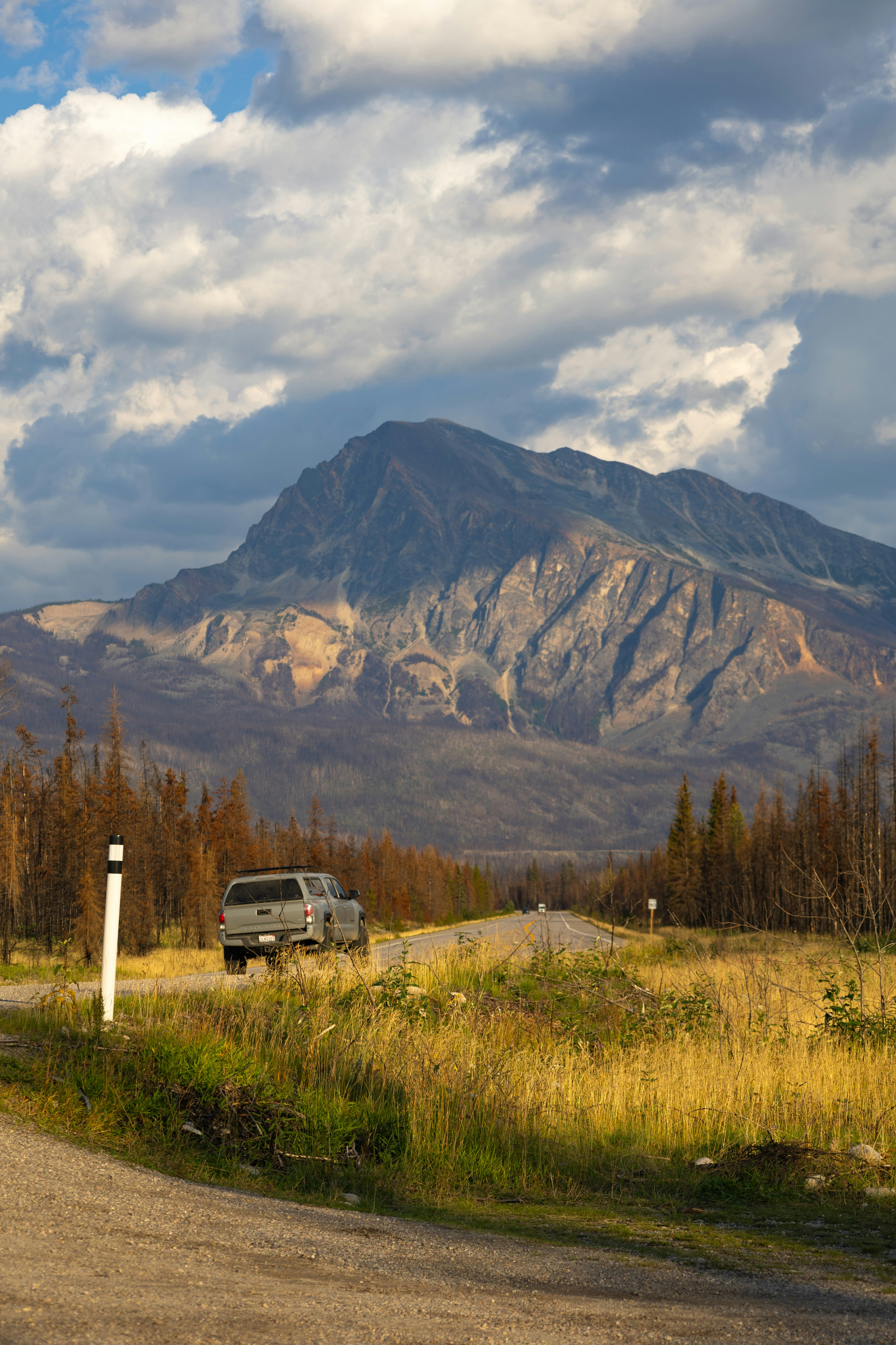Ridgebound: A Lone Truck Traverses a Quiet Highway Toward a Mountain Crown
