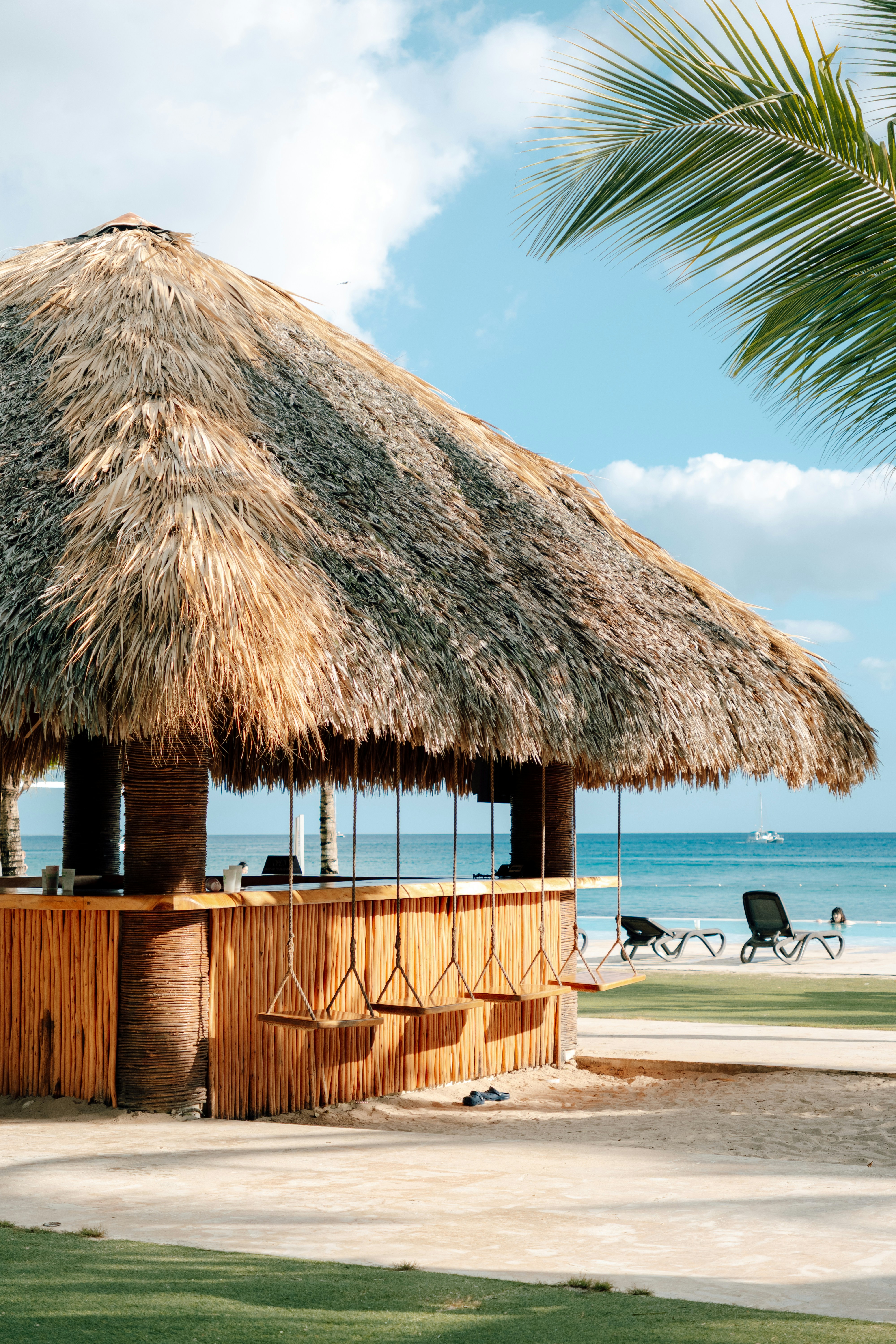 Tropical beach bar with swings and lounge chairs photo – Free Beach ...