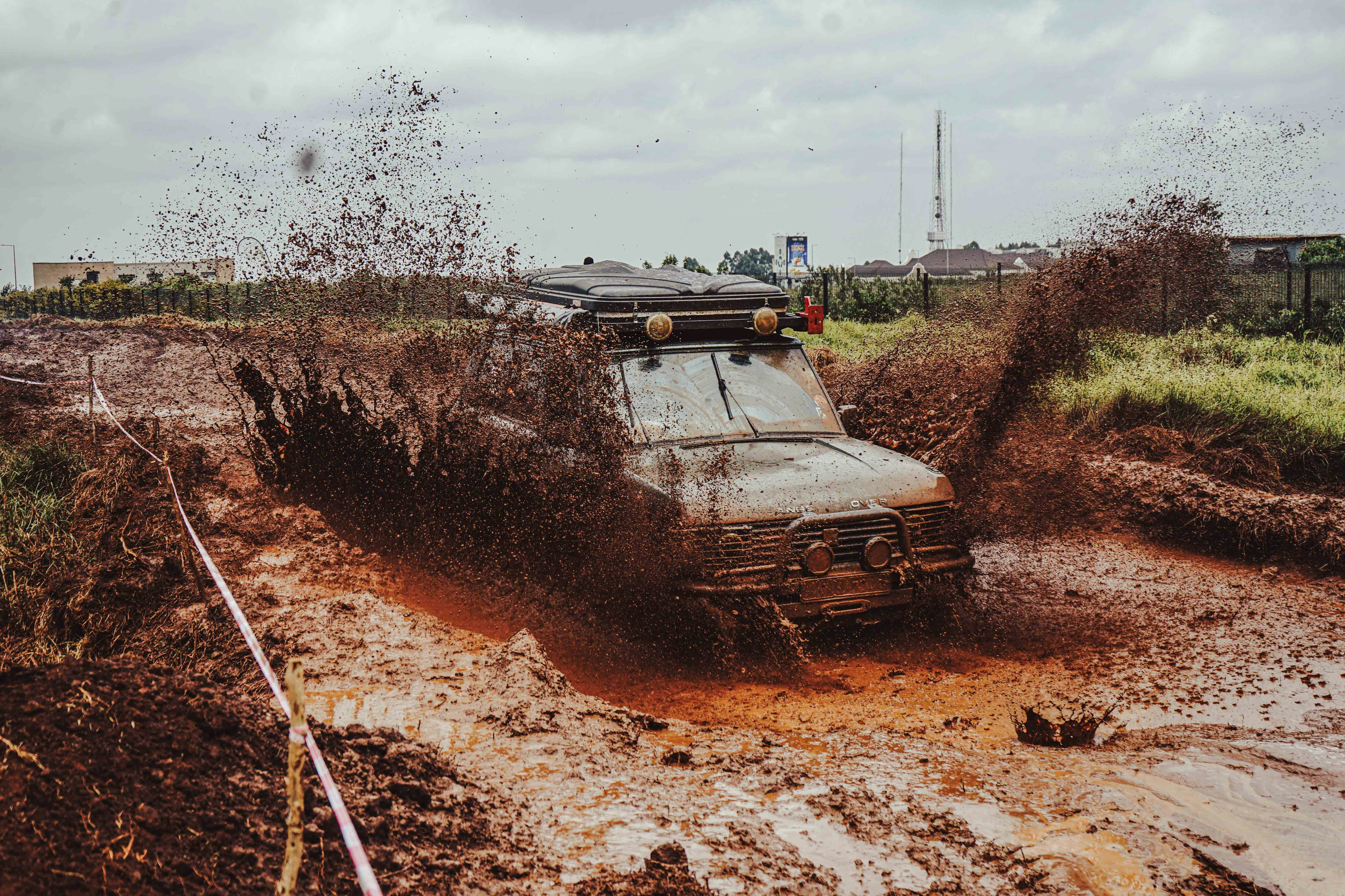 Mud Splash Rally: Off-Road Truck Surges Through a Caliber of Brown Water