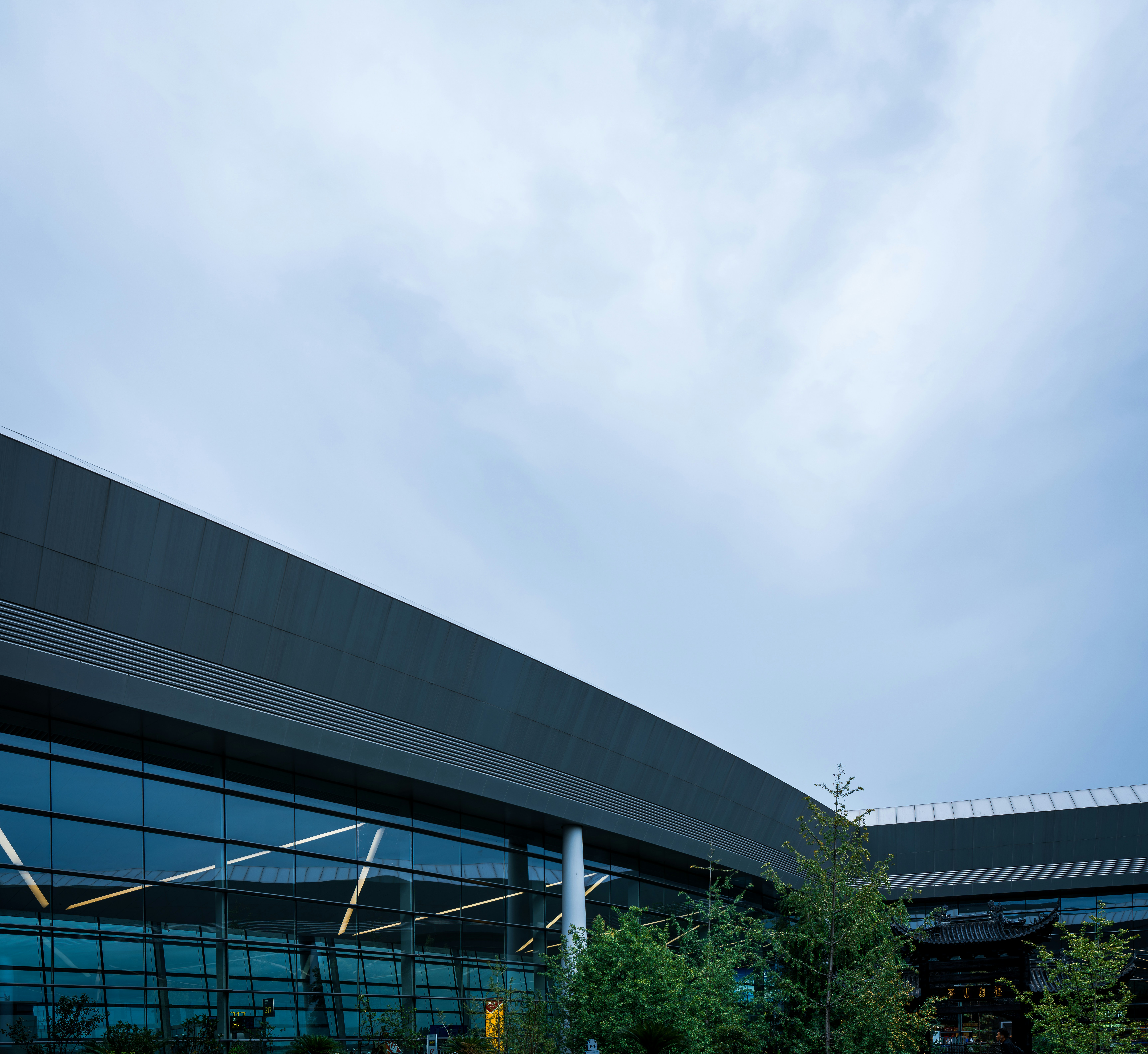 Glass Facade in Blue Light: Diagonal Edge of Modern Architecture
