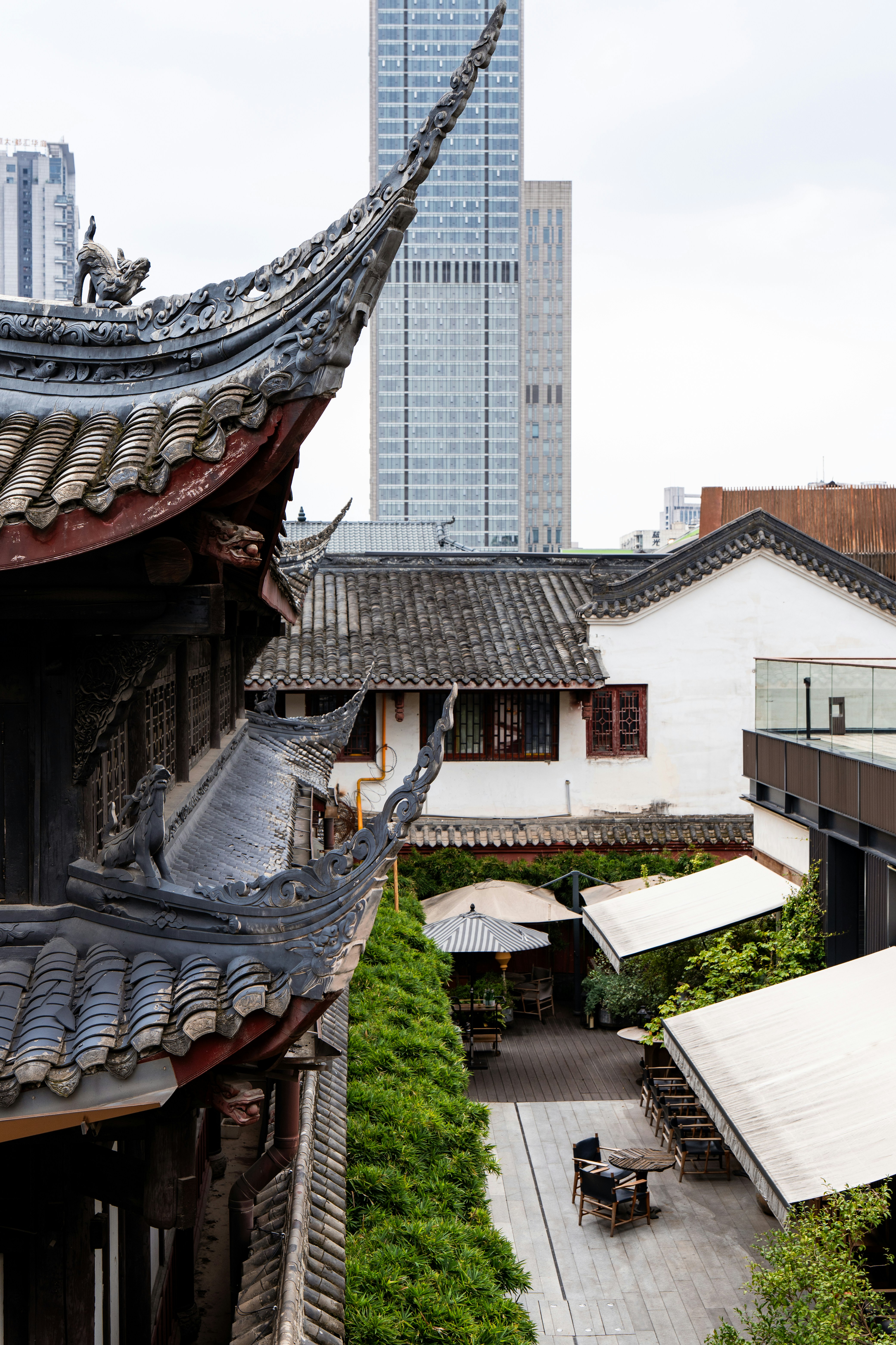 Dragon-Scroll Roofline Meets a Glass Skyline