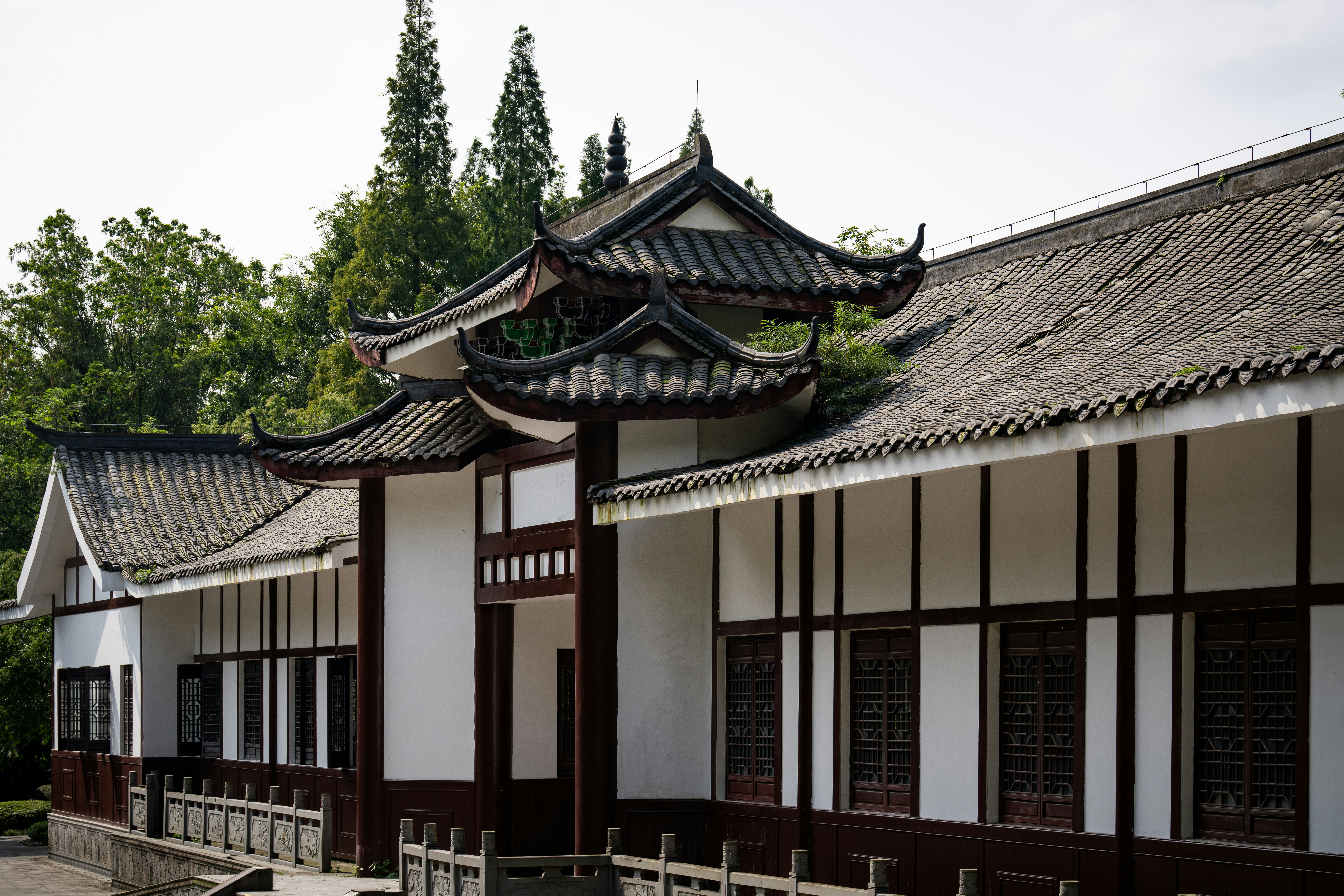 Traditional chinese architecture with ornate roofs and white walls.