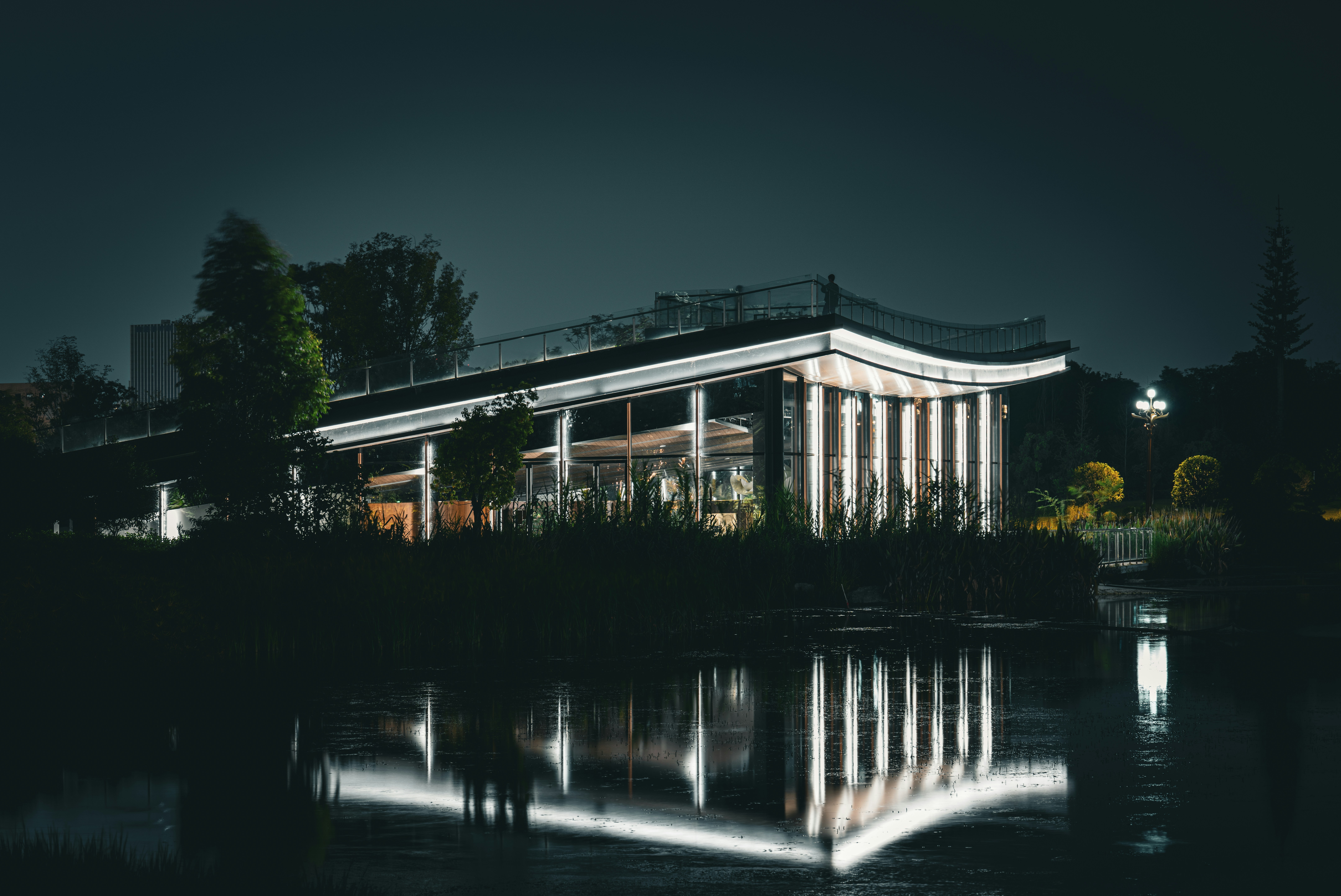 Modern building with traditional asian roof at night.
