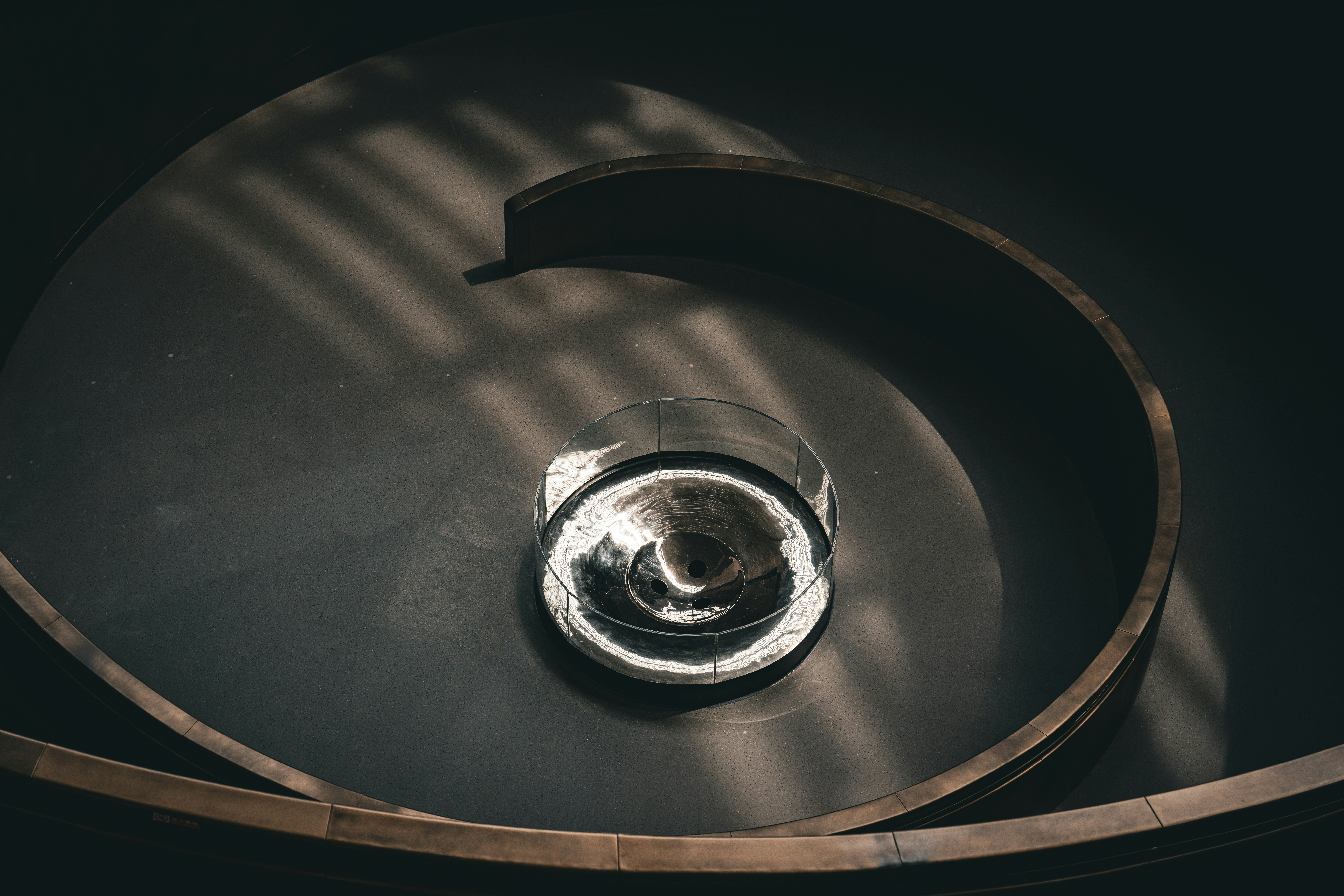 Modern spiral staircase with dramatic lighting