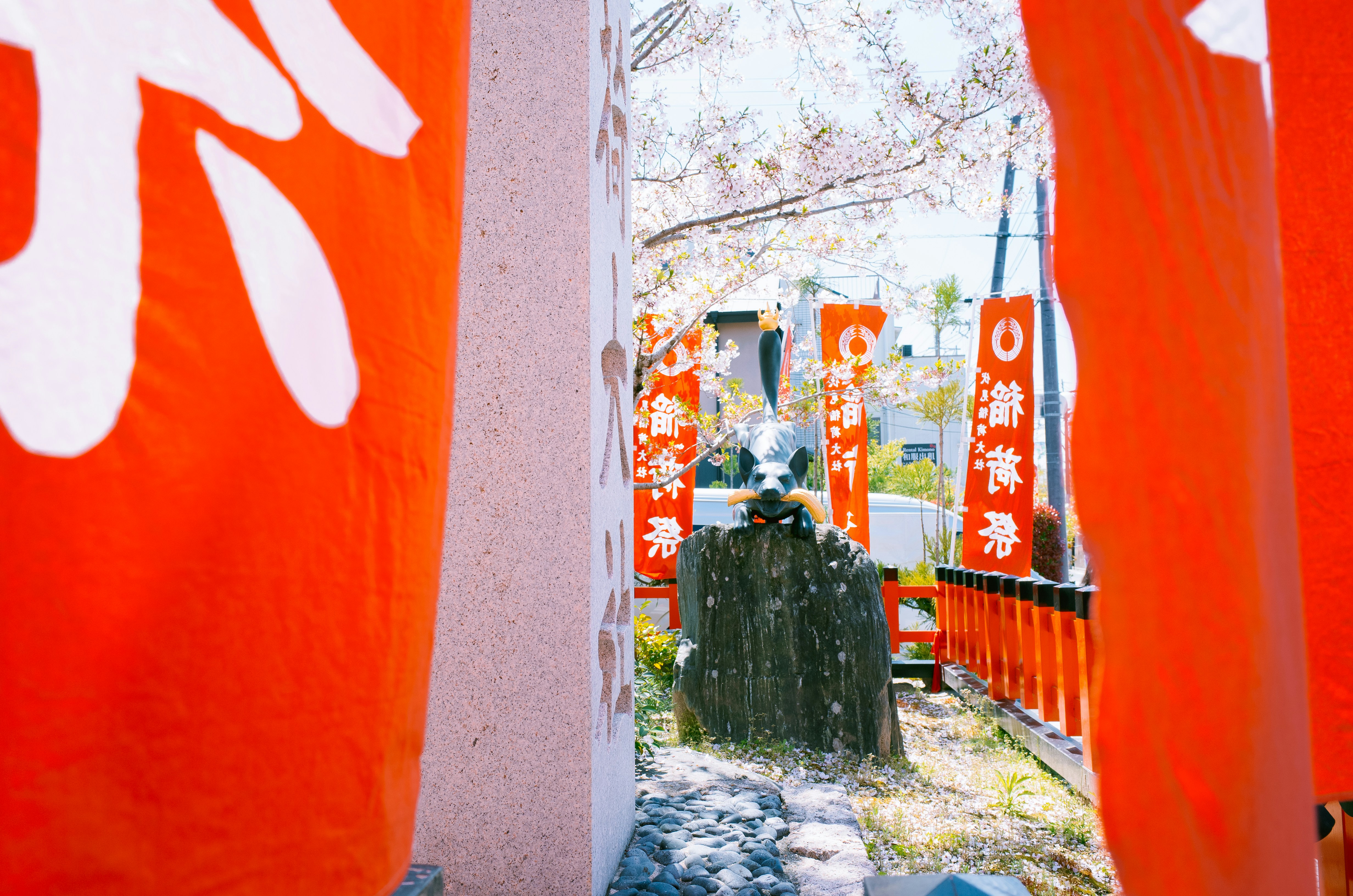 Crimson Frame: Shrine Statue Between Snowy Banners