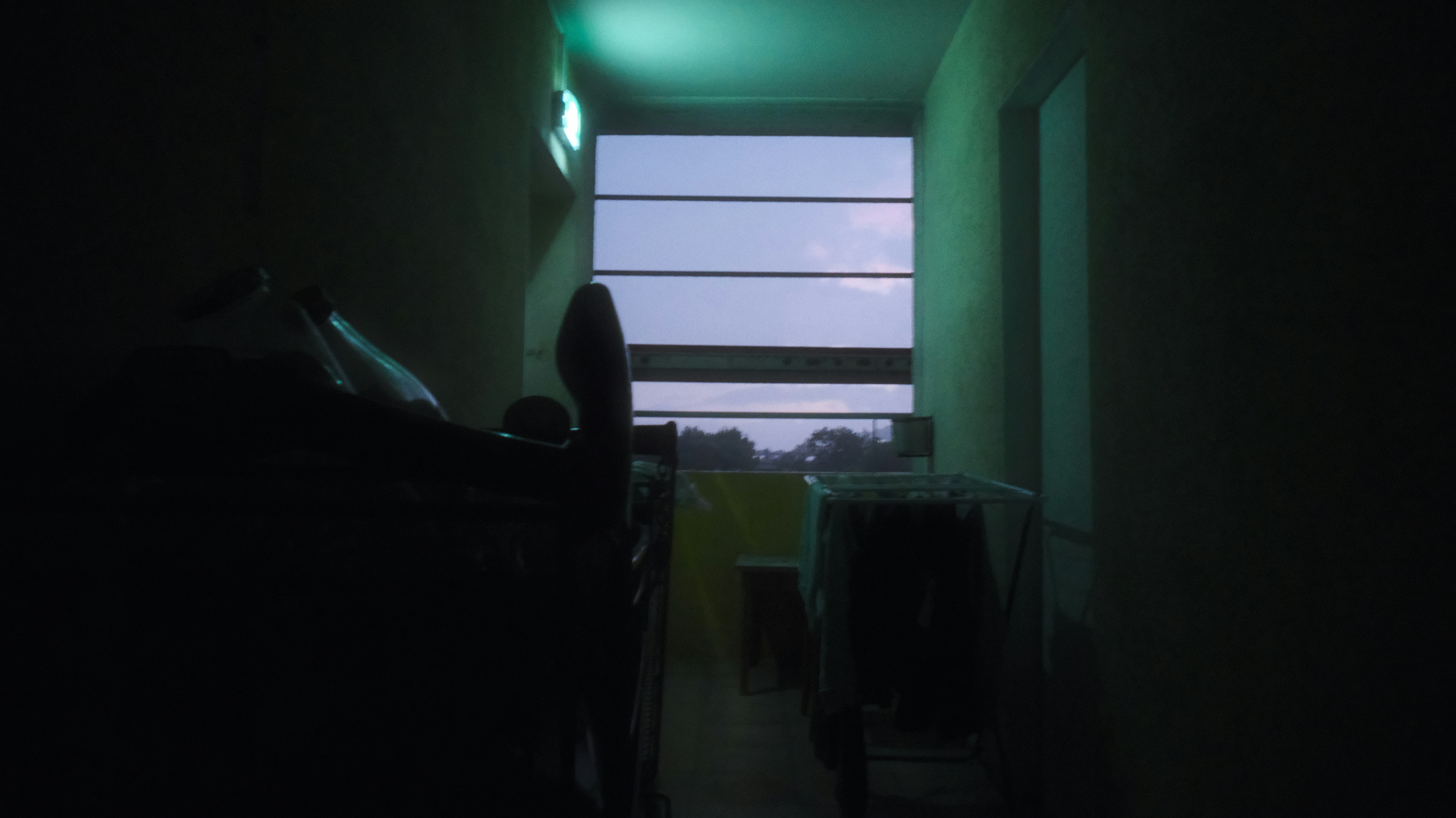 Dark hallway with a window showing the sky