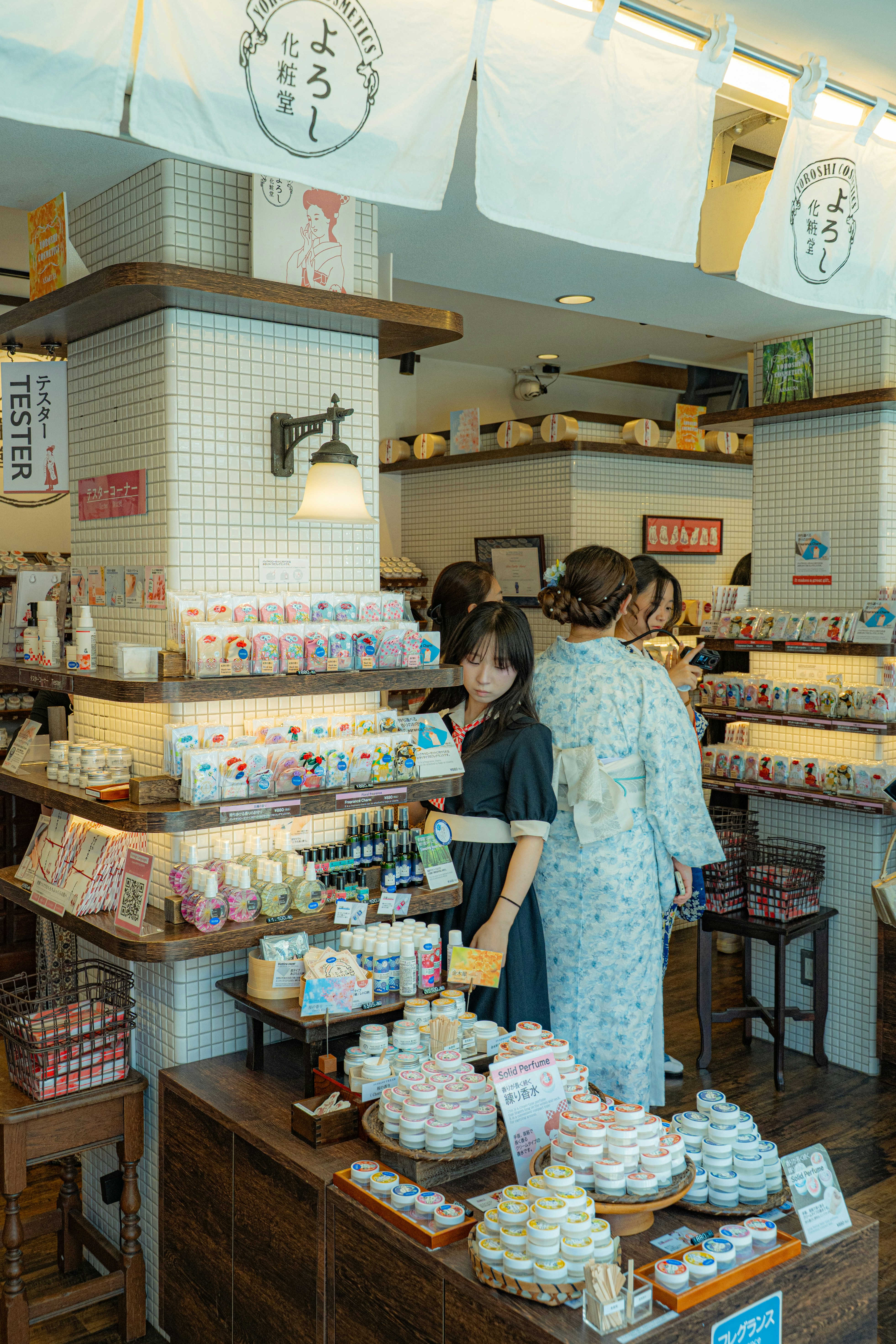 Customers browsing skincare products in a brightly lit store.