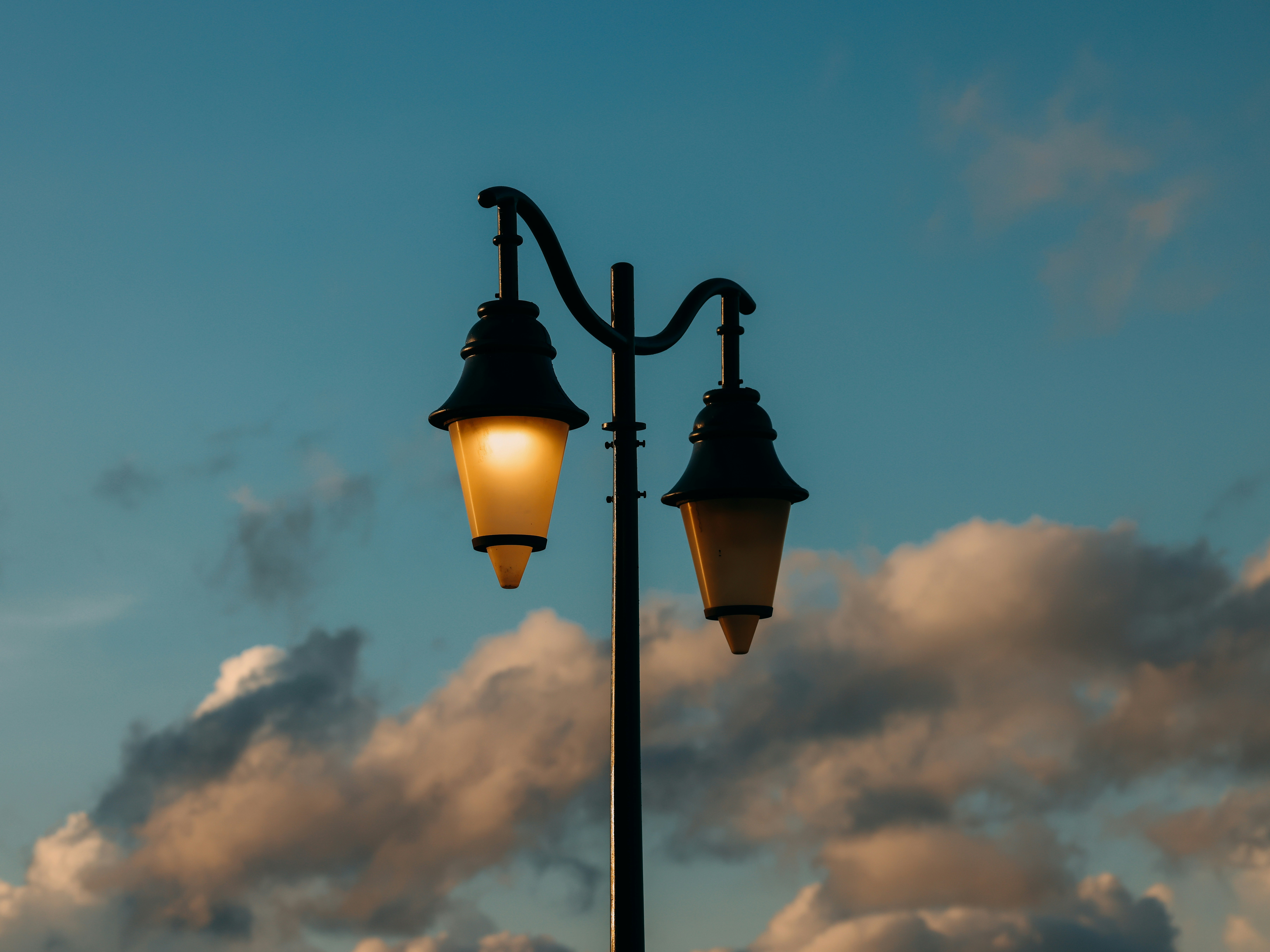 Street lamp against a cloudy blue sky