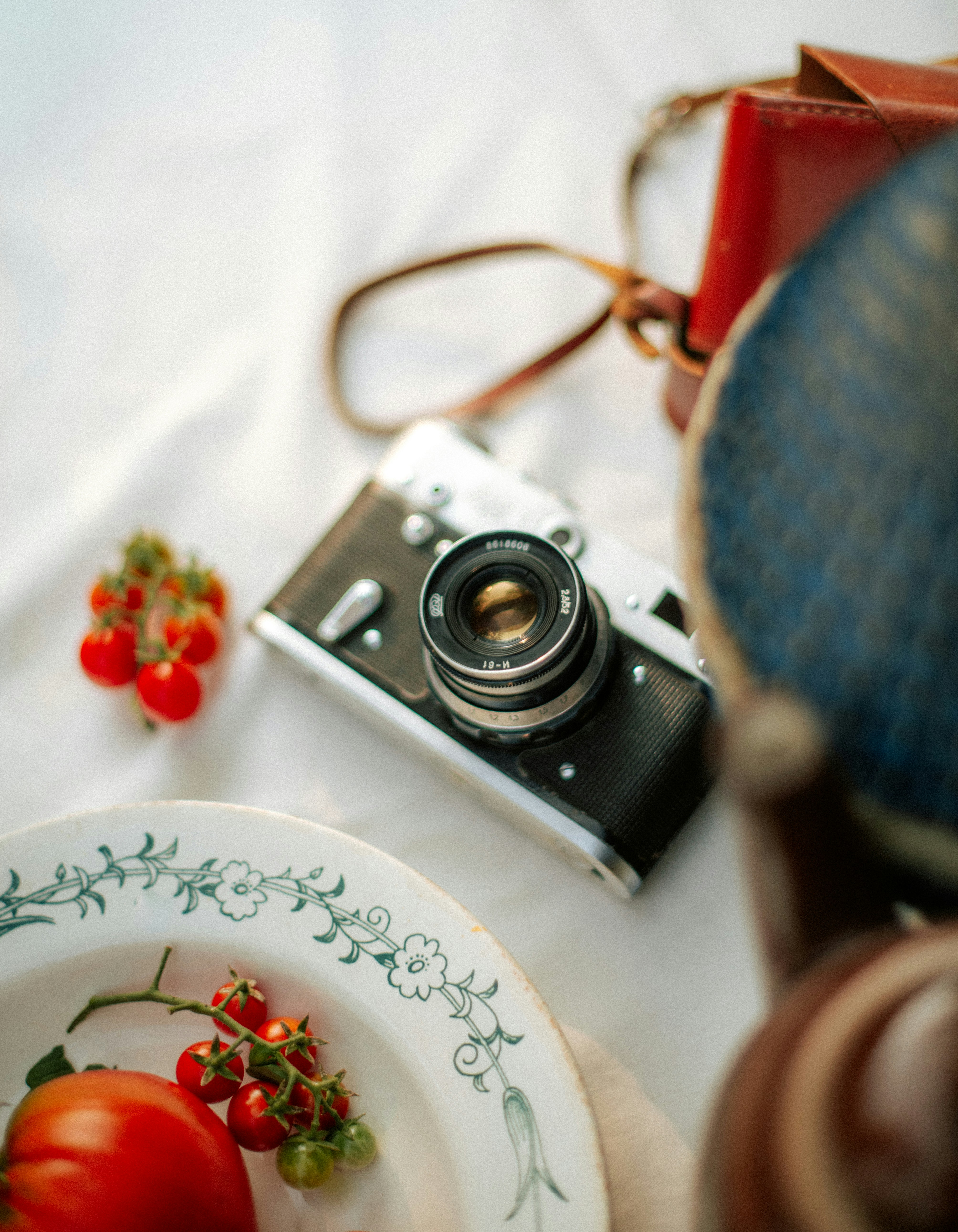Vintage camera with tomatoes and plate on white cloth photo – Free ...