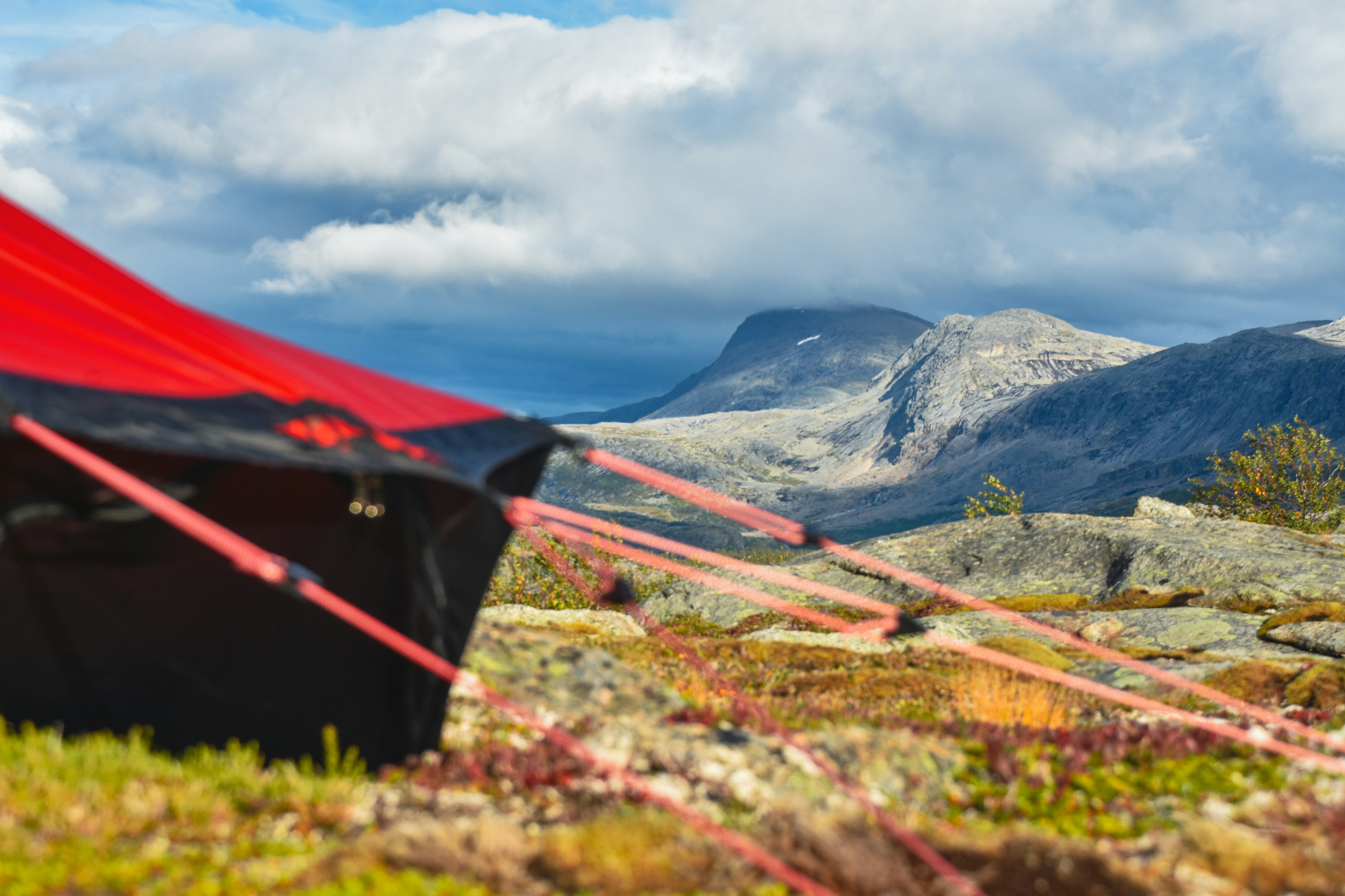 Red Tent, Rugged Peak: A Campsite Beside Alpine Rocks