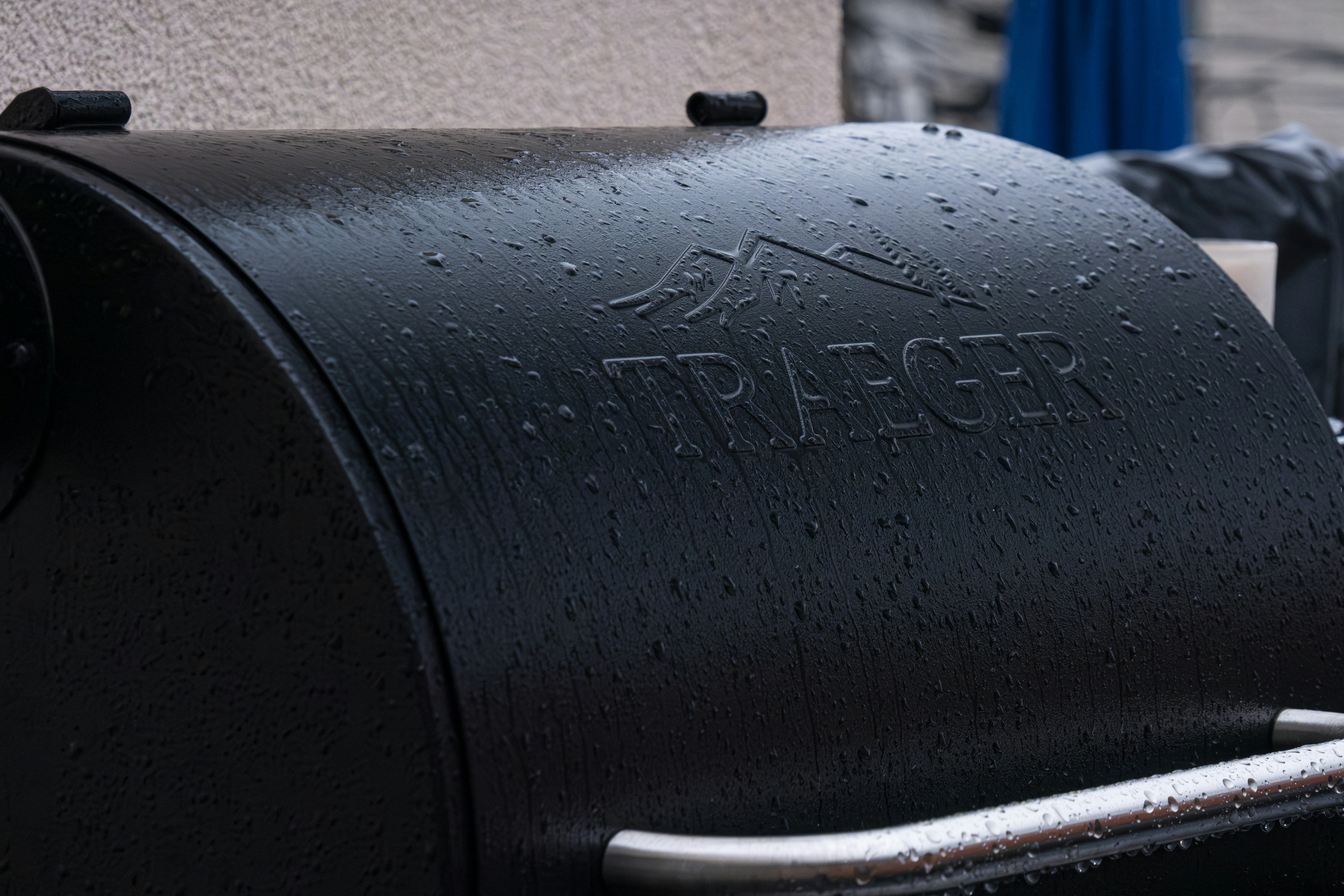 TRAEGER black grill with rain drops on it | Black grill lid with water droplets and logo