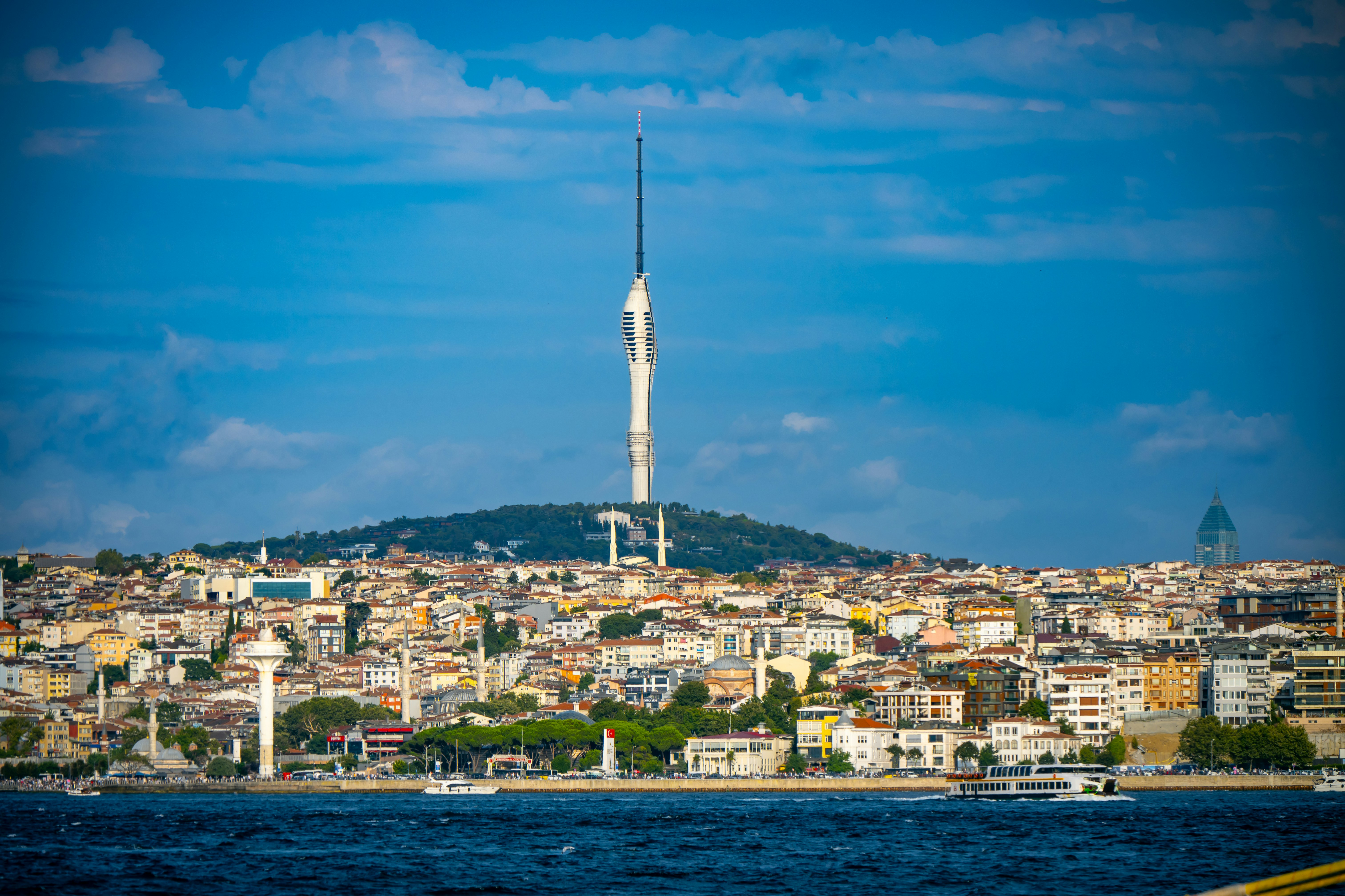 Hilltop Spire Over a Sea-Bound City