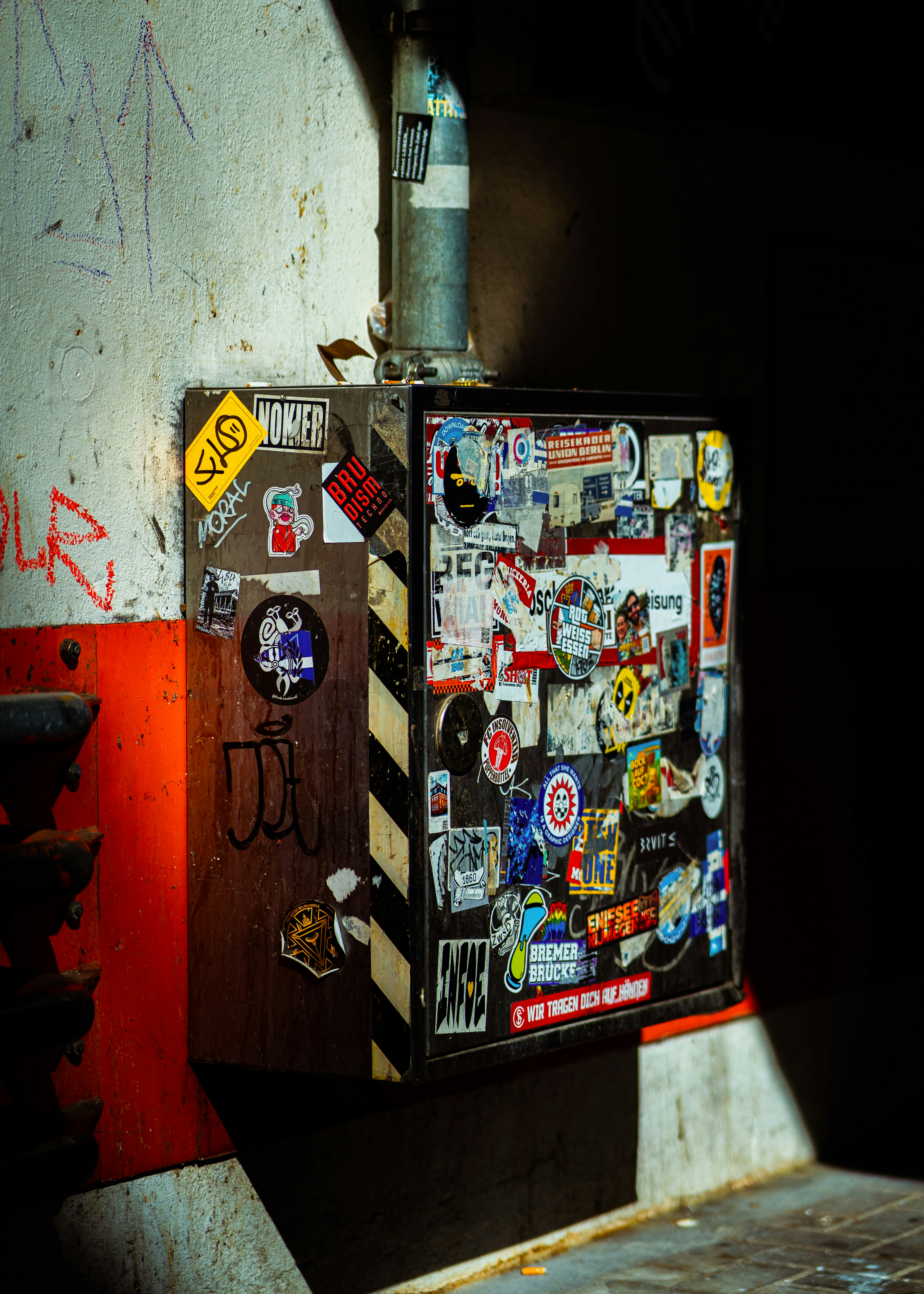 Utility box covered in colorful stickers