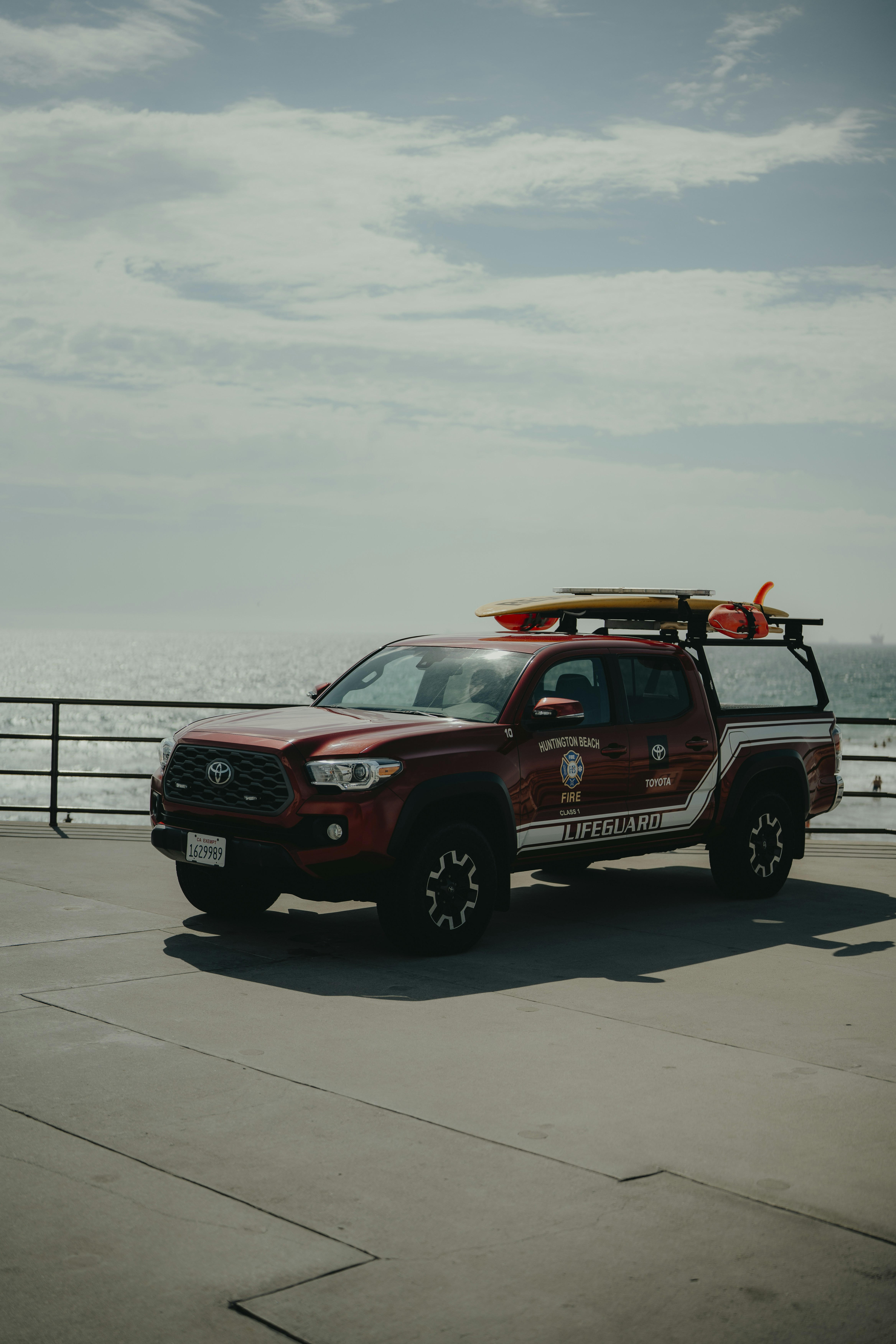 Crimson Lifeguard Truck by the Pier: Maritime Readiness in Sunlit Salt Air