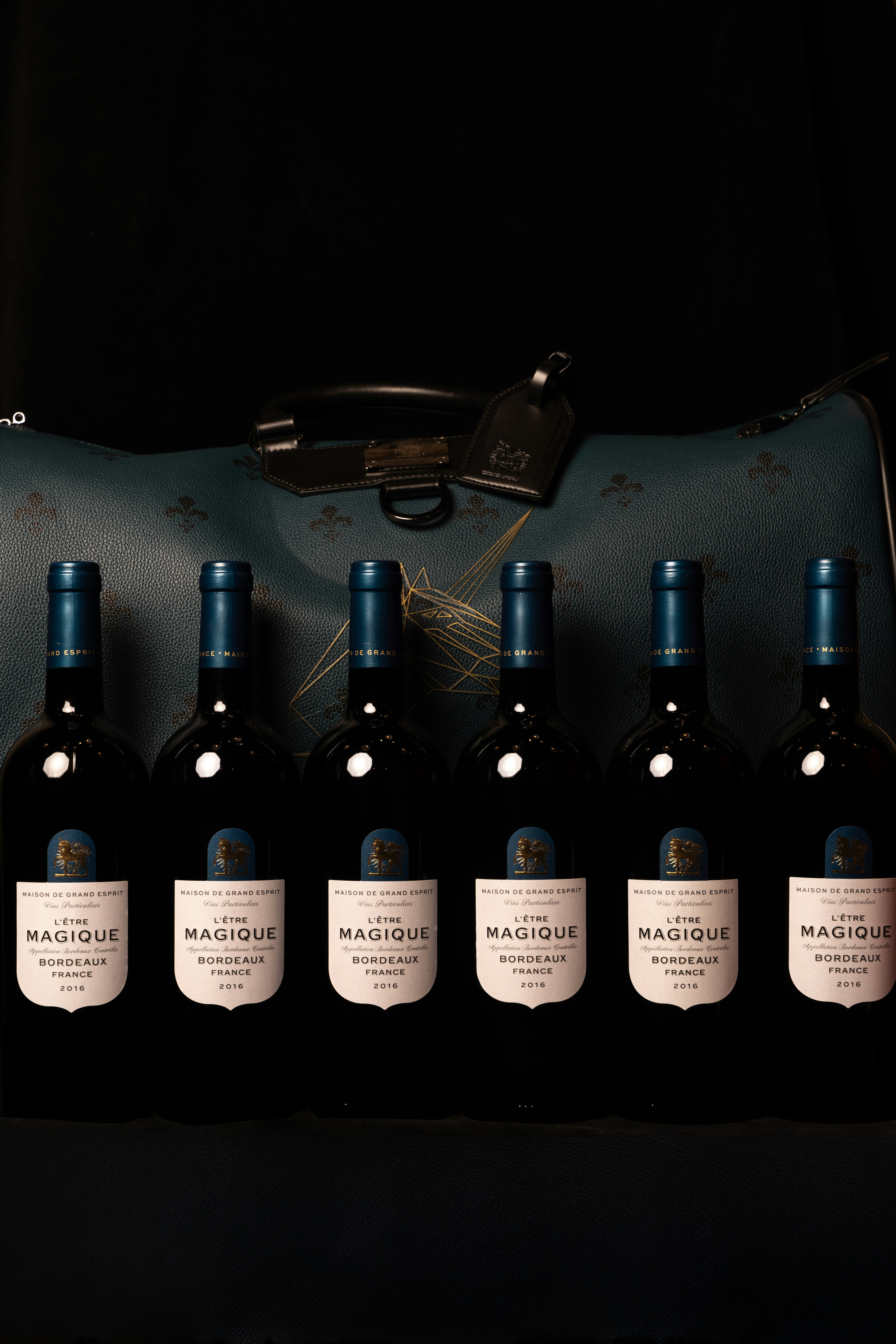 Six bottles of wine arranged in a row.