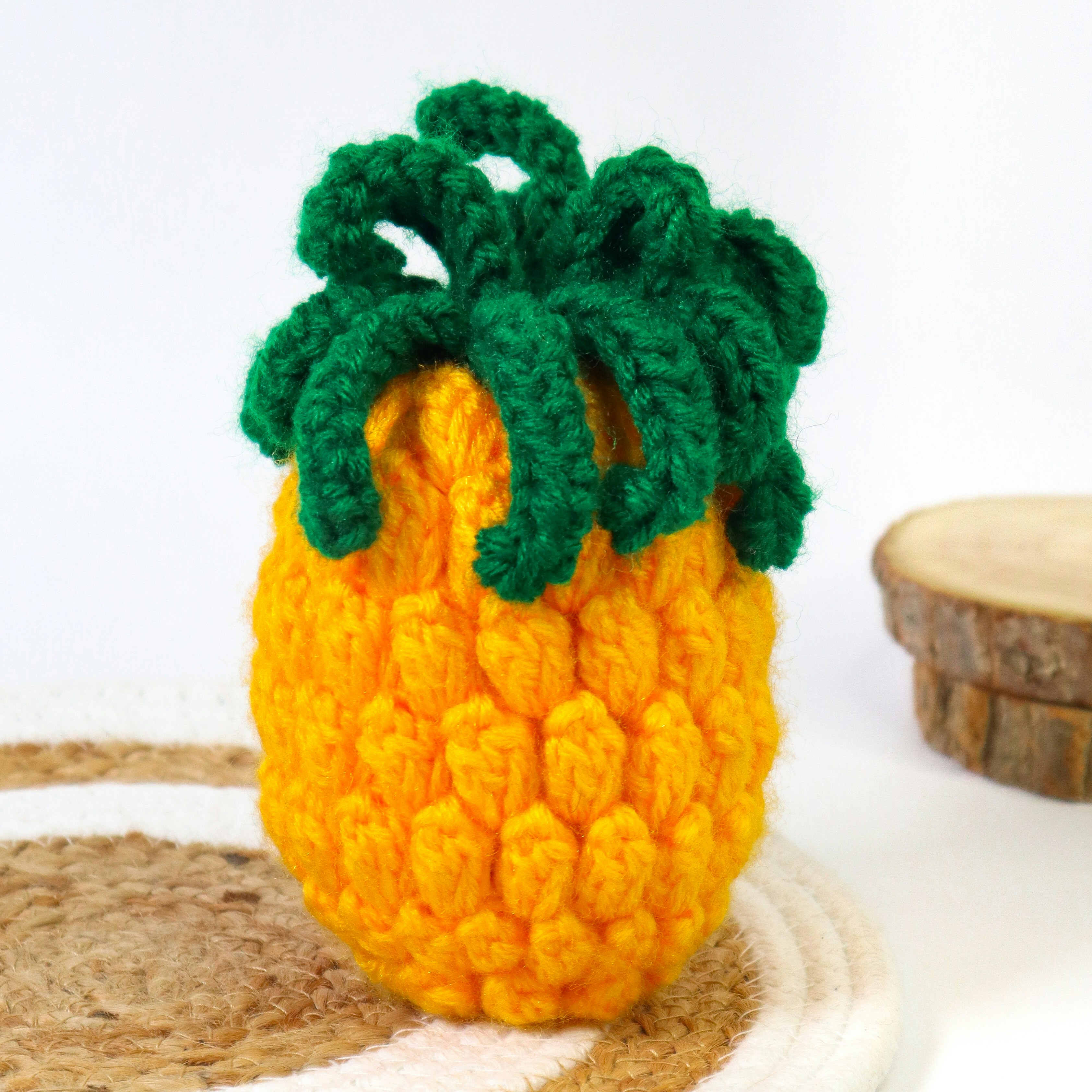 Crocheted Pineapple with Plush Green Crown: A Sunny Amigurumi Still Life