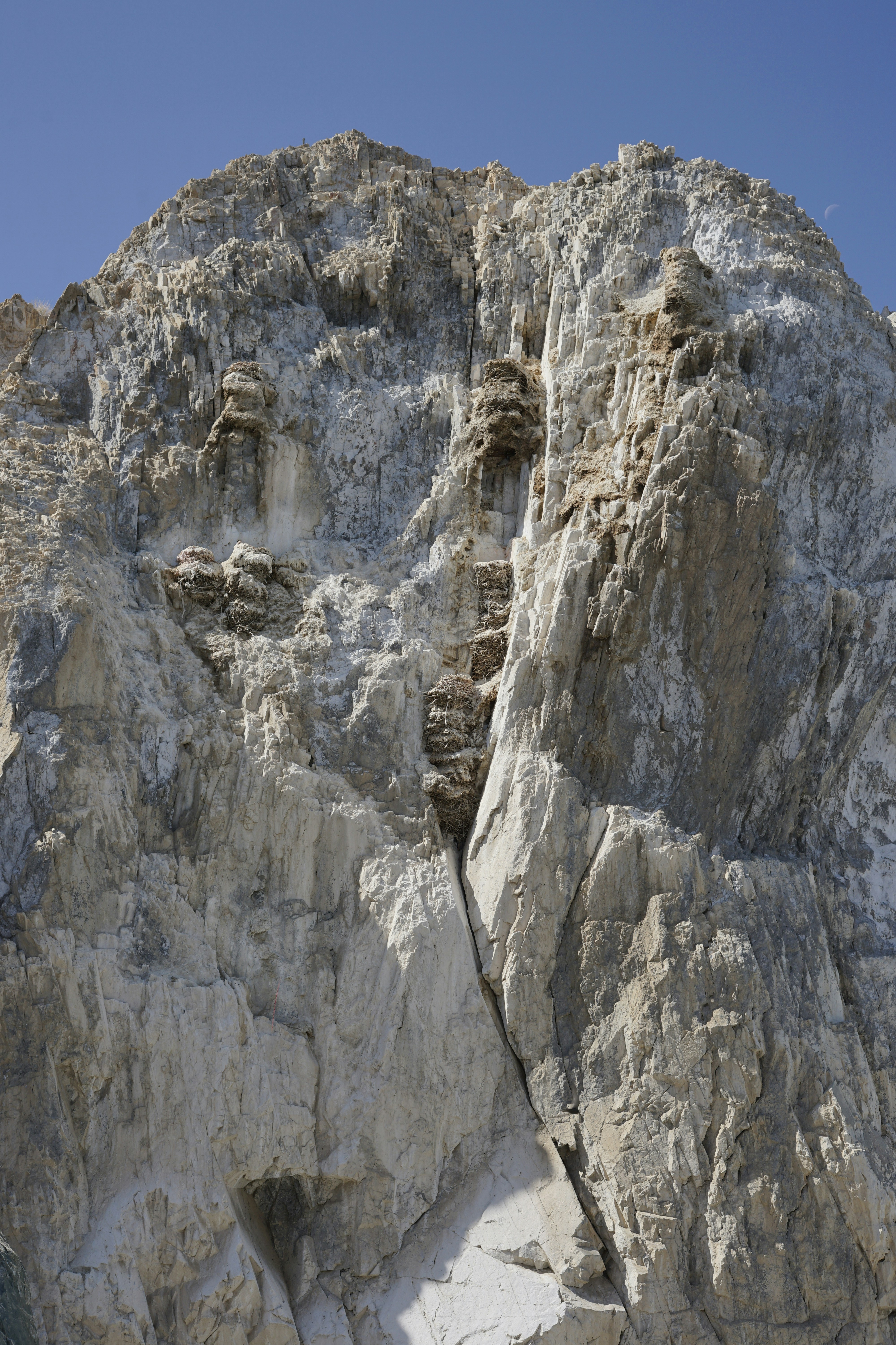 Jagged rock face under a clear blue sky