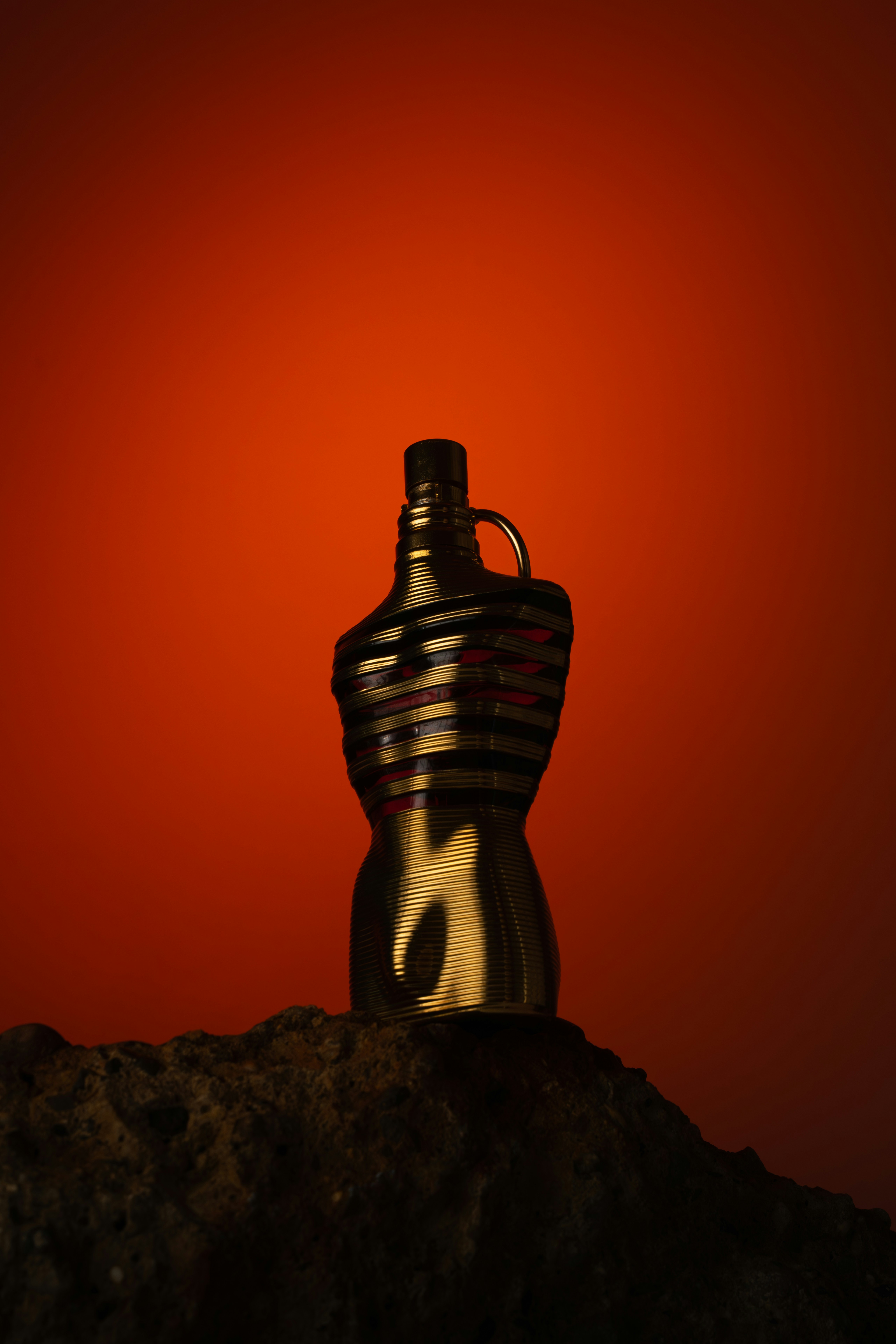 The Elegance of Form: A Metallic Sculpture Against Fiery Hues