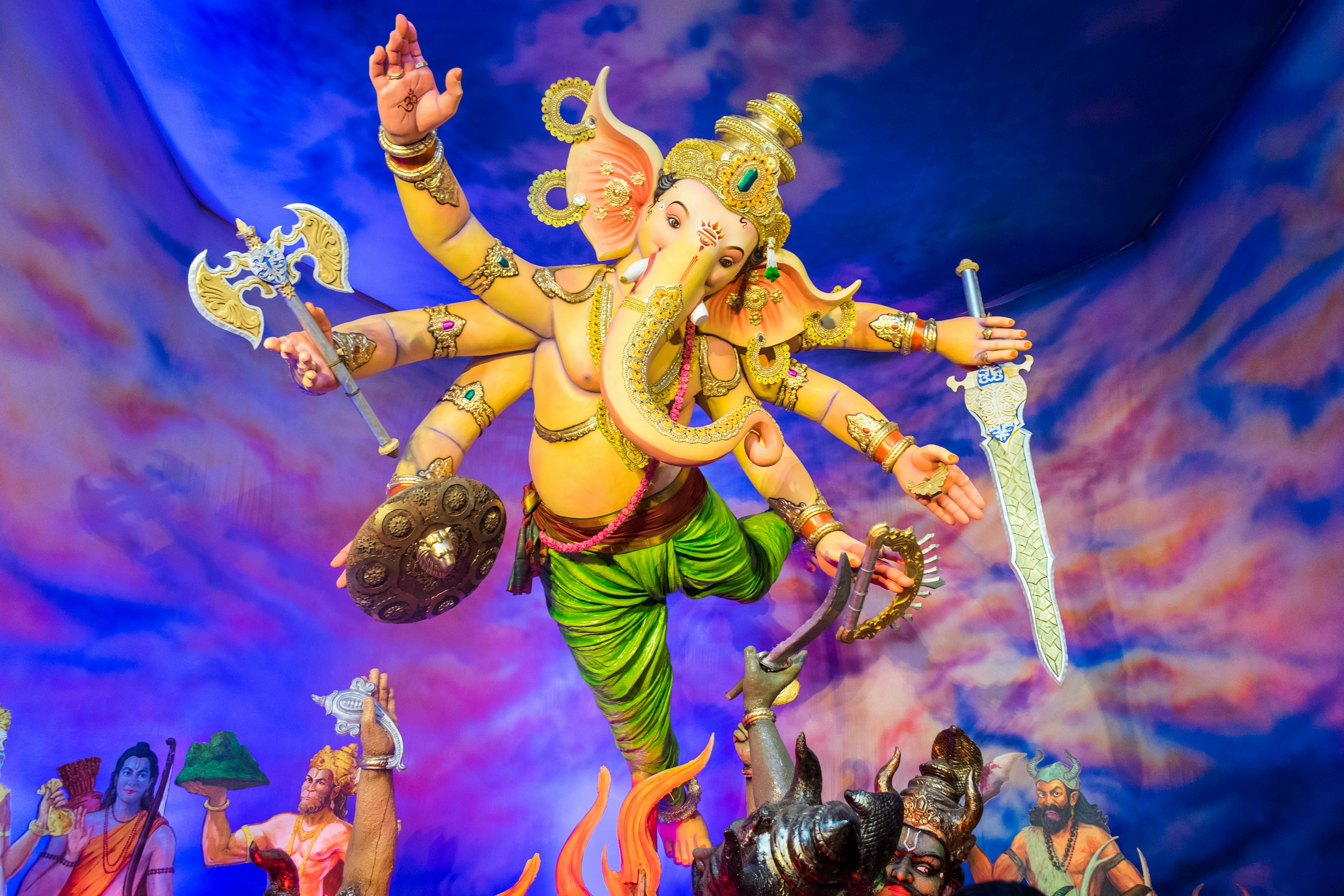 A multi-armed statue of ganesha holds weapons photo – Free Ganesh Image ...