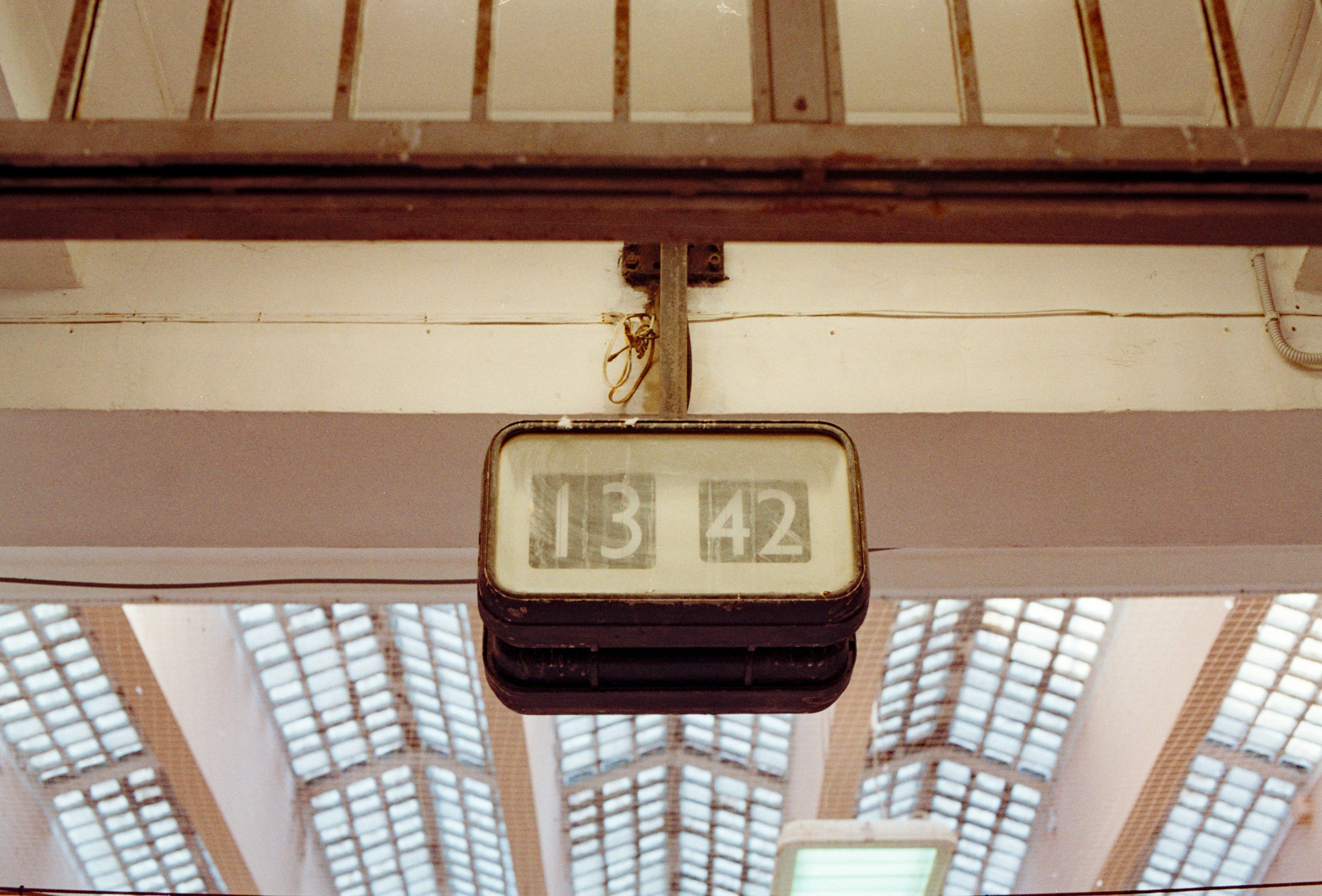 Flip clock showing 13:42 hanging from ceiling