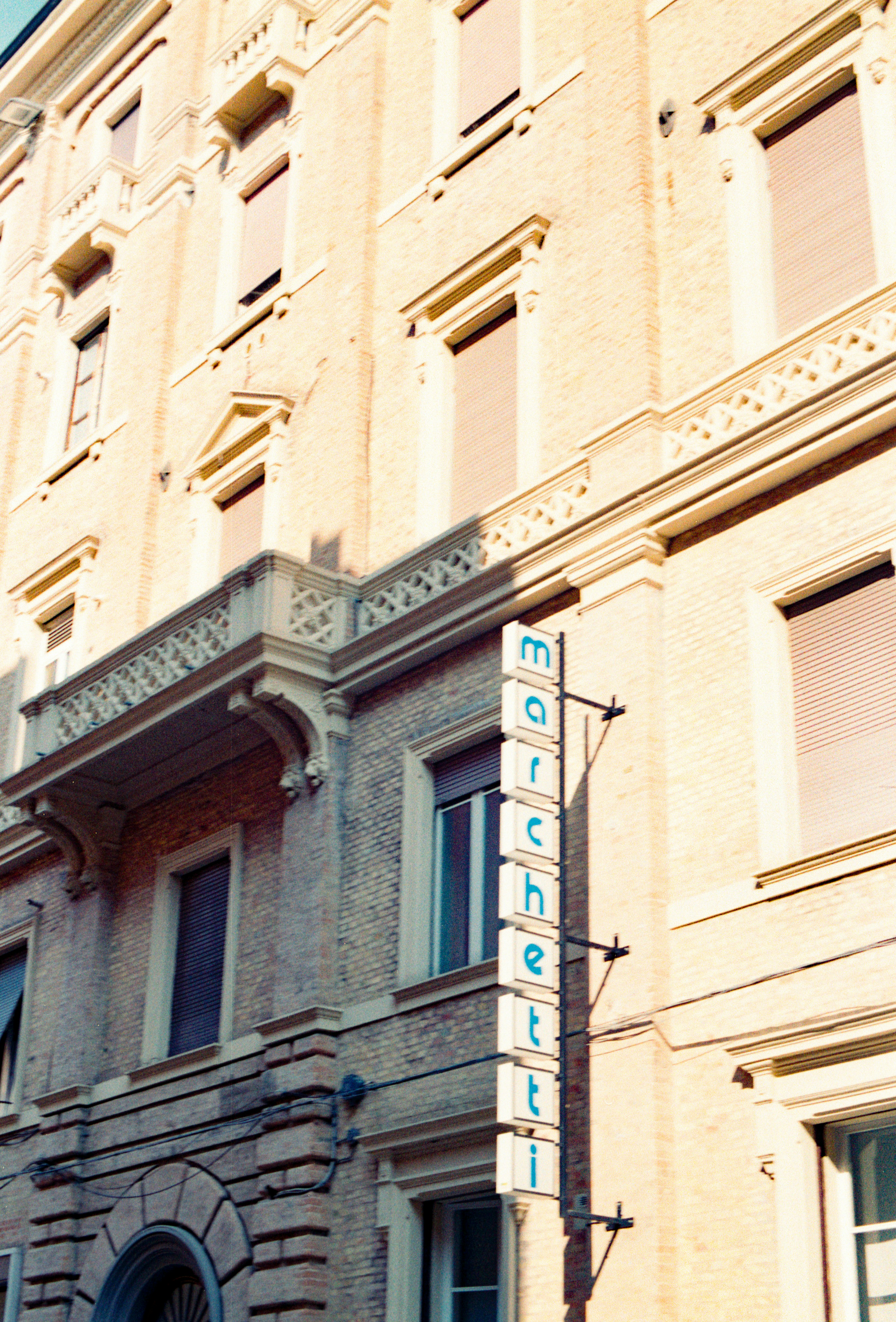 Building facade with a marchetti sign