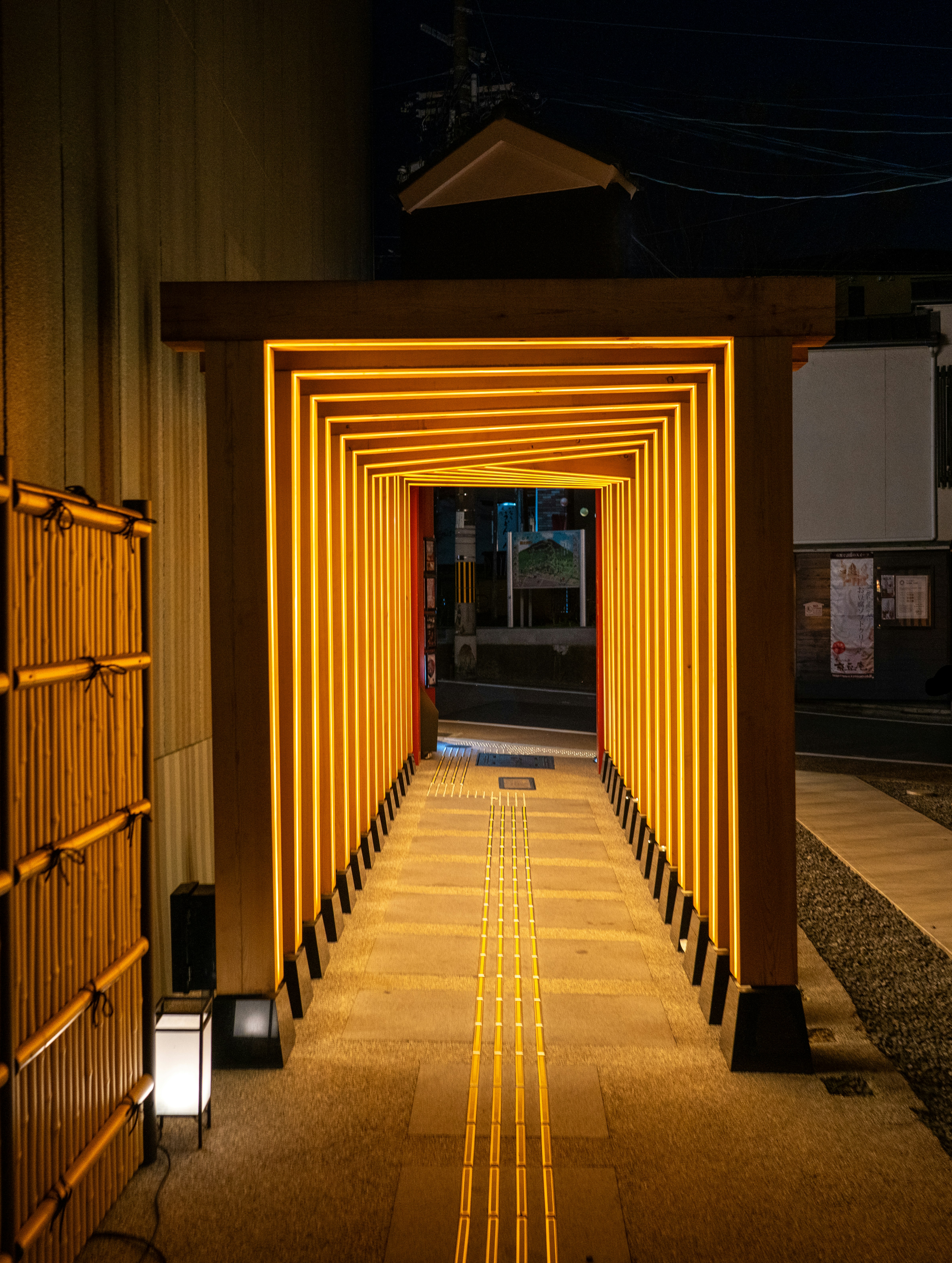 Kyoto, Japan | Illuminated pathway through a wooden archway at night