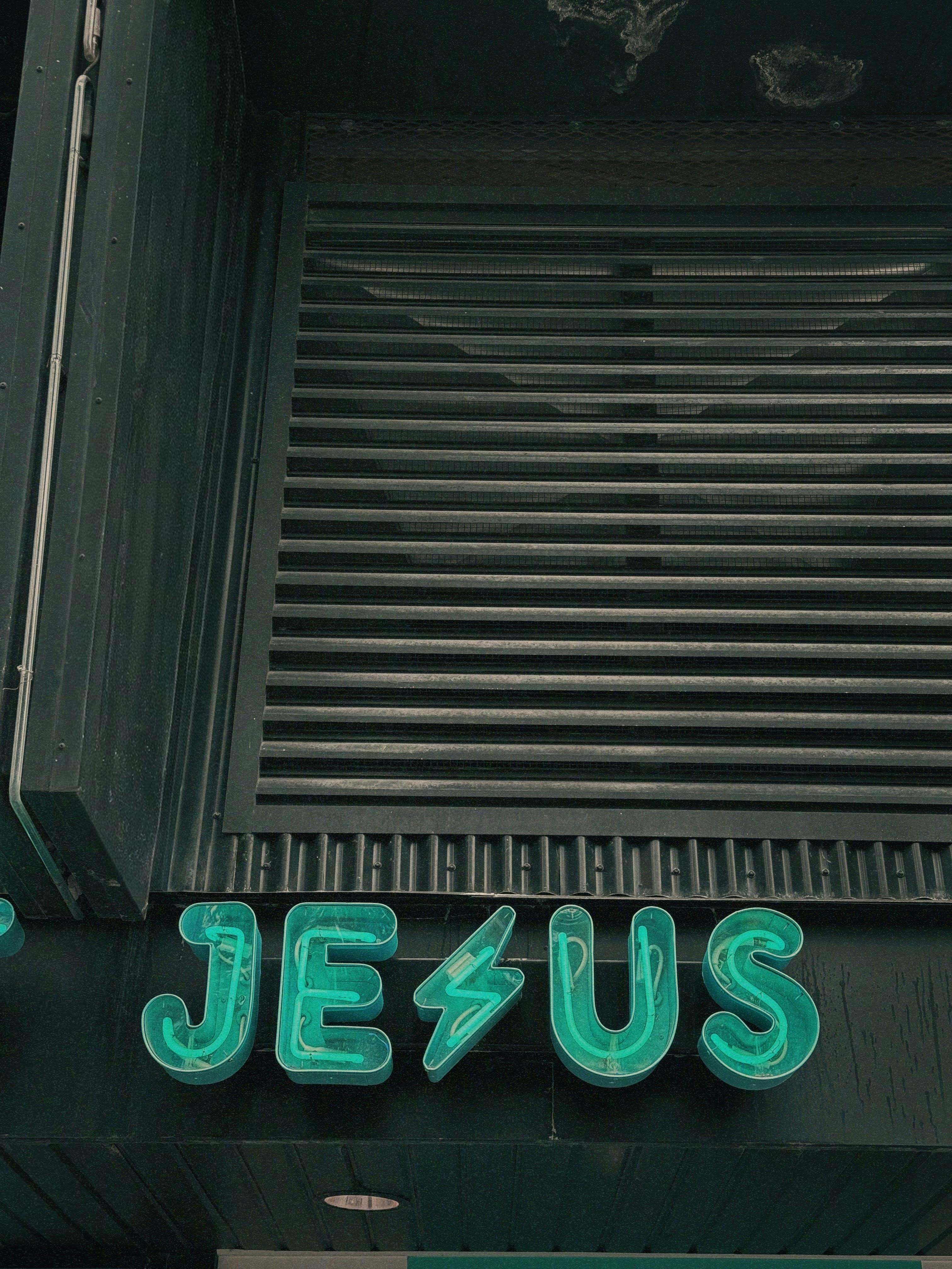 Neon sign spelling jesus with a lightning bolt. photo – Free Jesus ...
