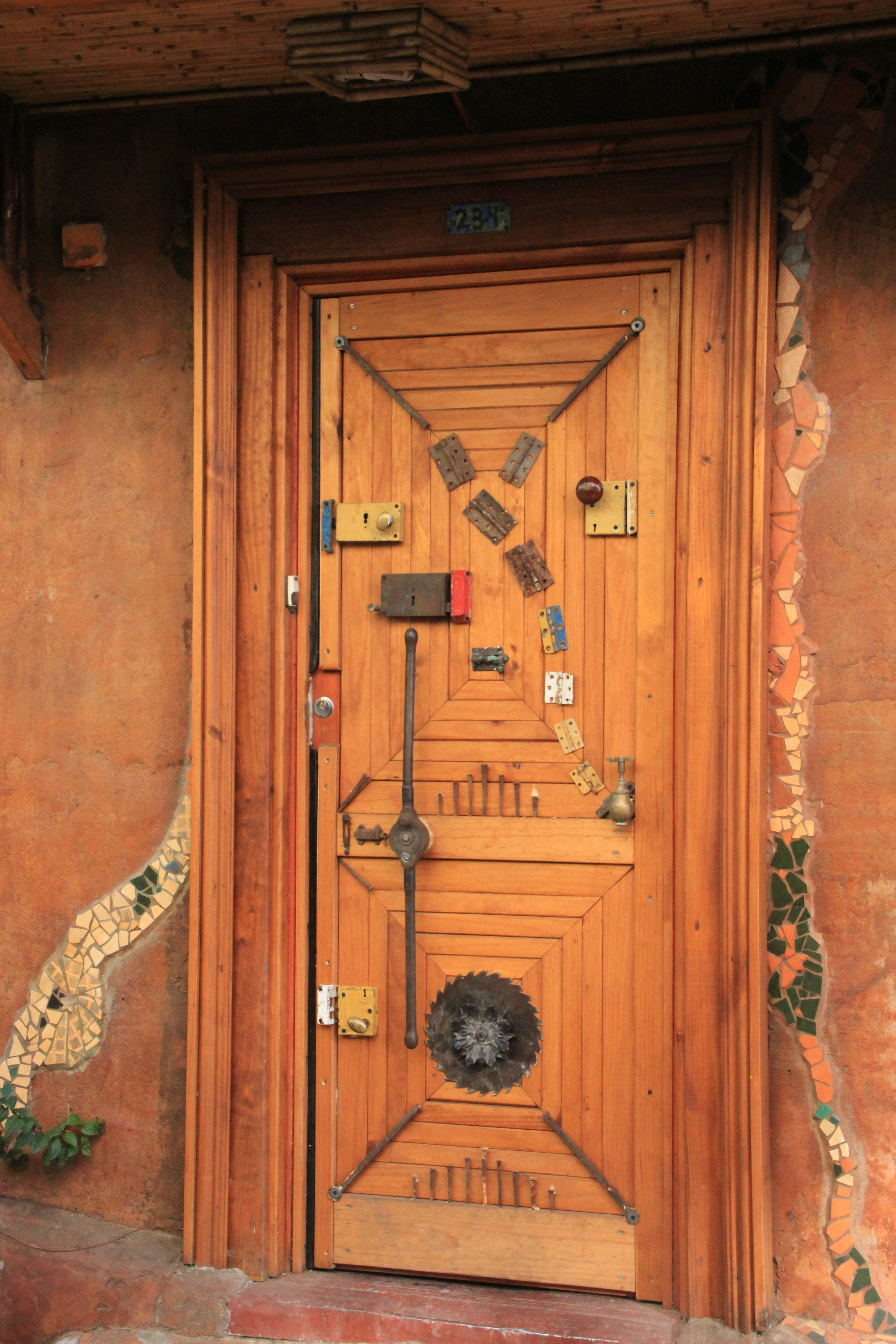 Doorway of Secrets: A Weathered Portal Adorned with Letters and Tools