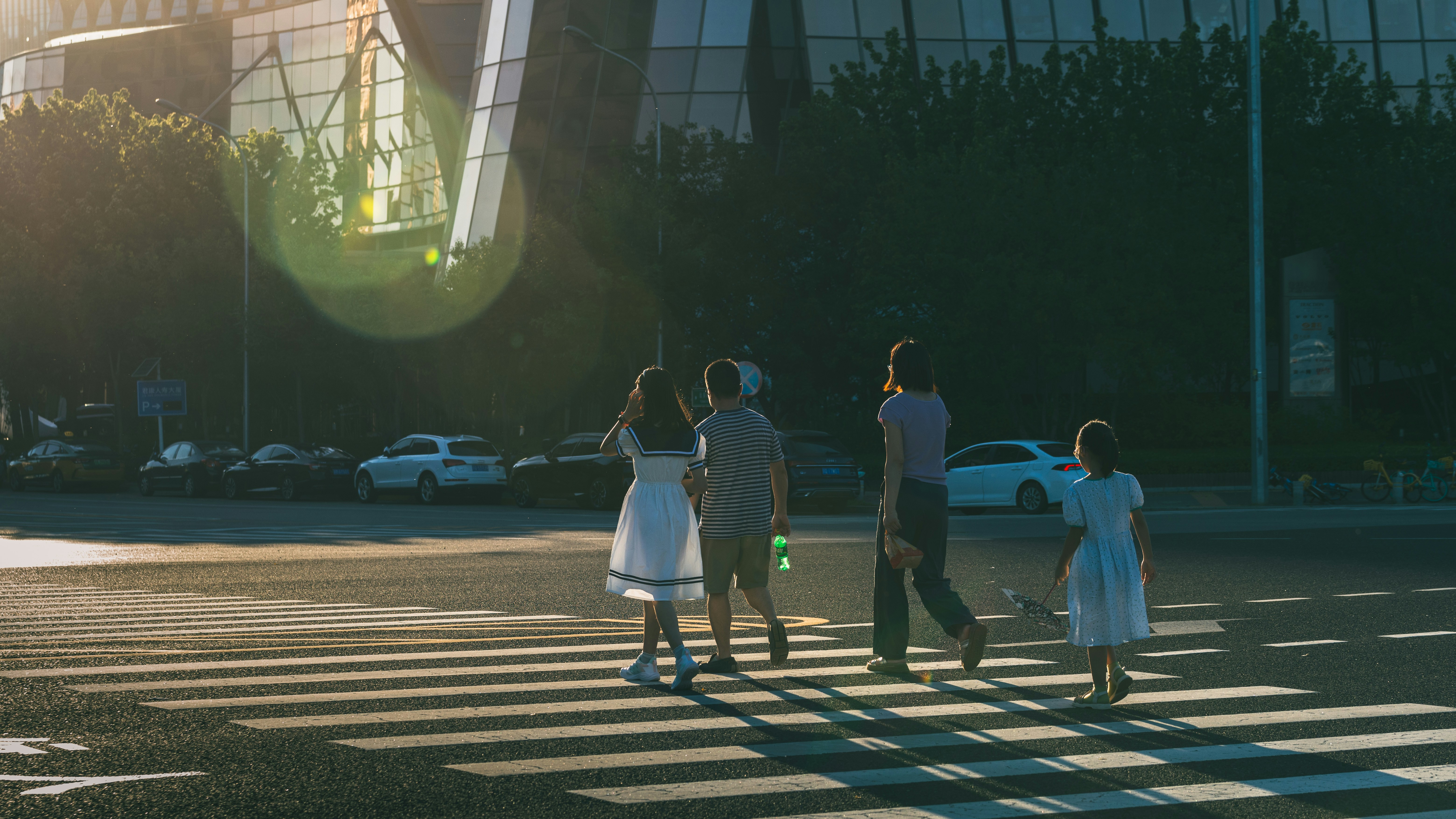 Evening Stroll: A Family's Journey Across the Crosswalk