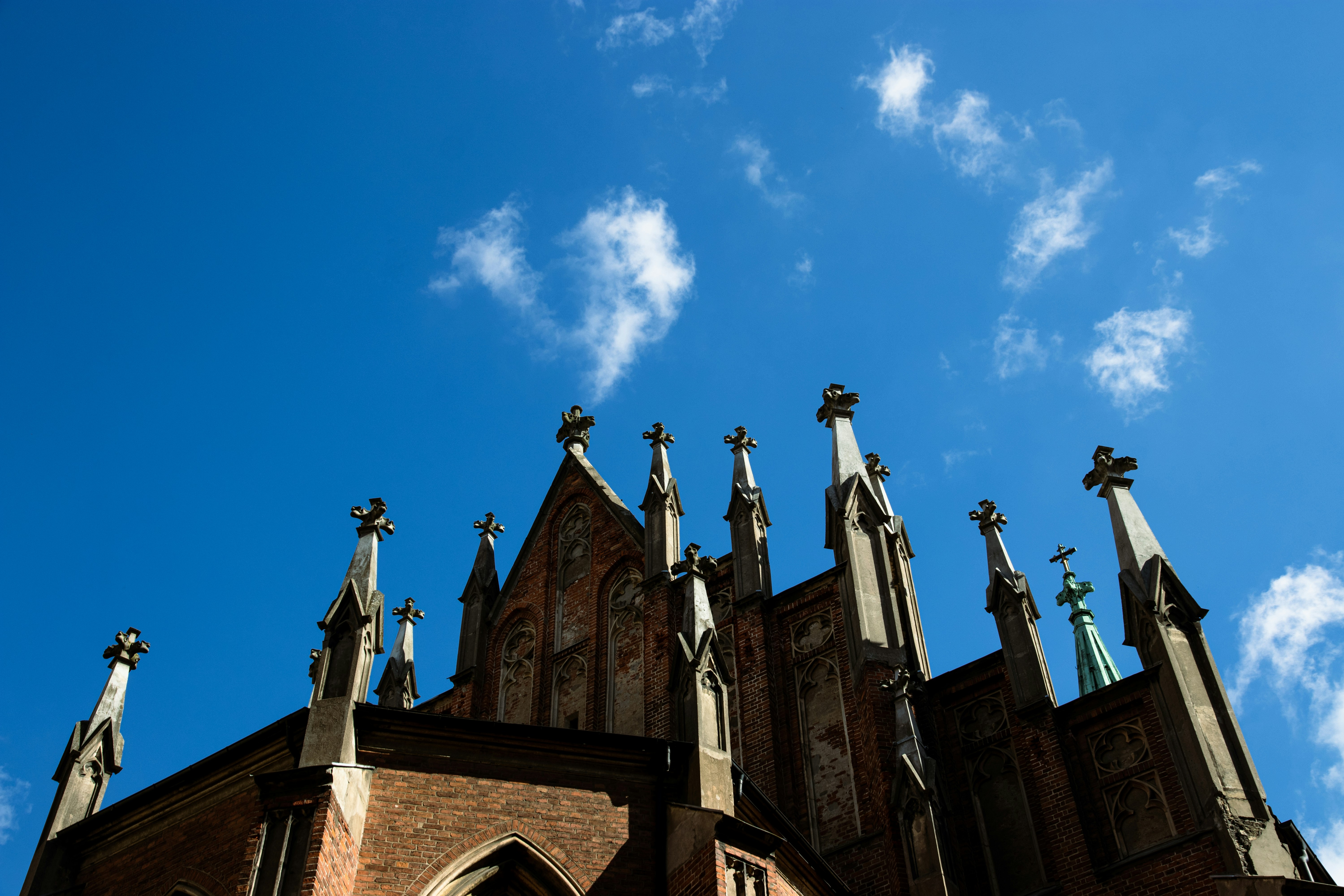 Gothic cathedral spire against a bright blue sky