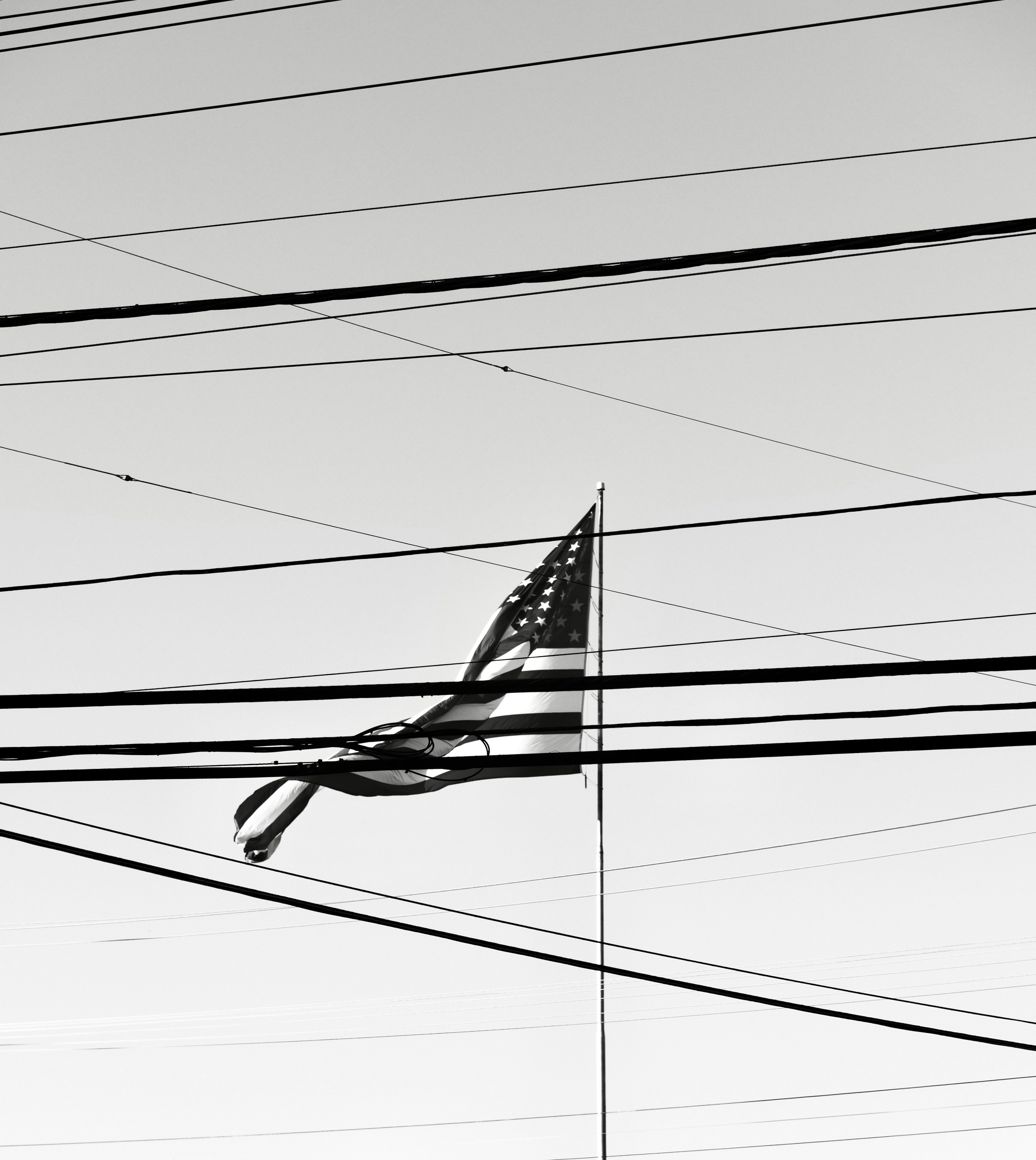 Threads of Patriotism: A Flag Amongst the Wires