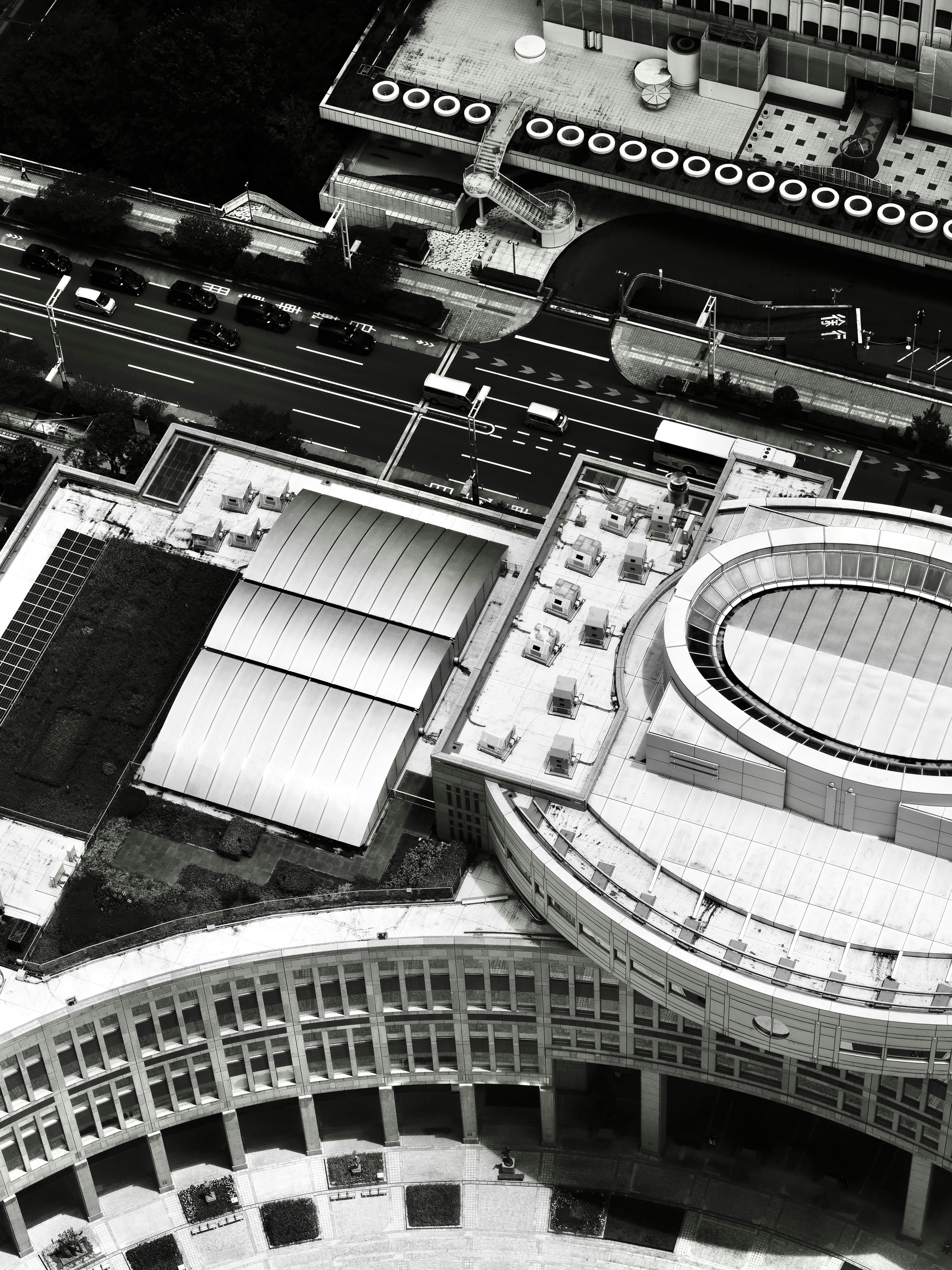 Monochrome Ring: The Circular Atrium Anchoring a Linear Cityscape