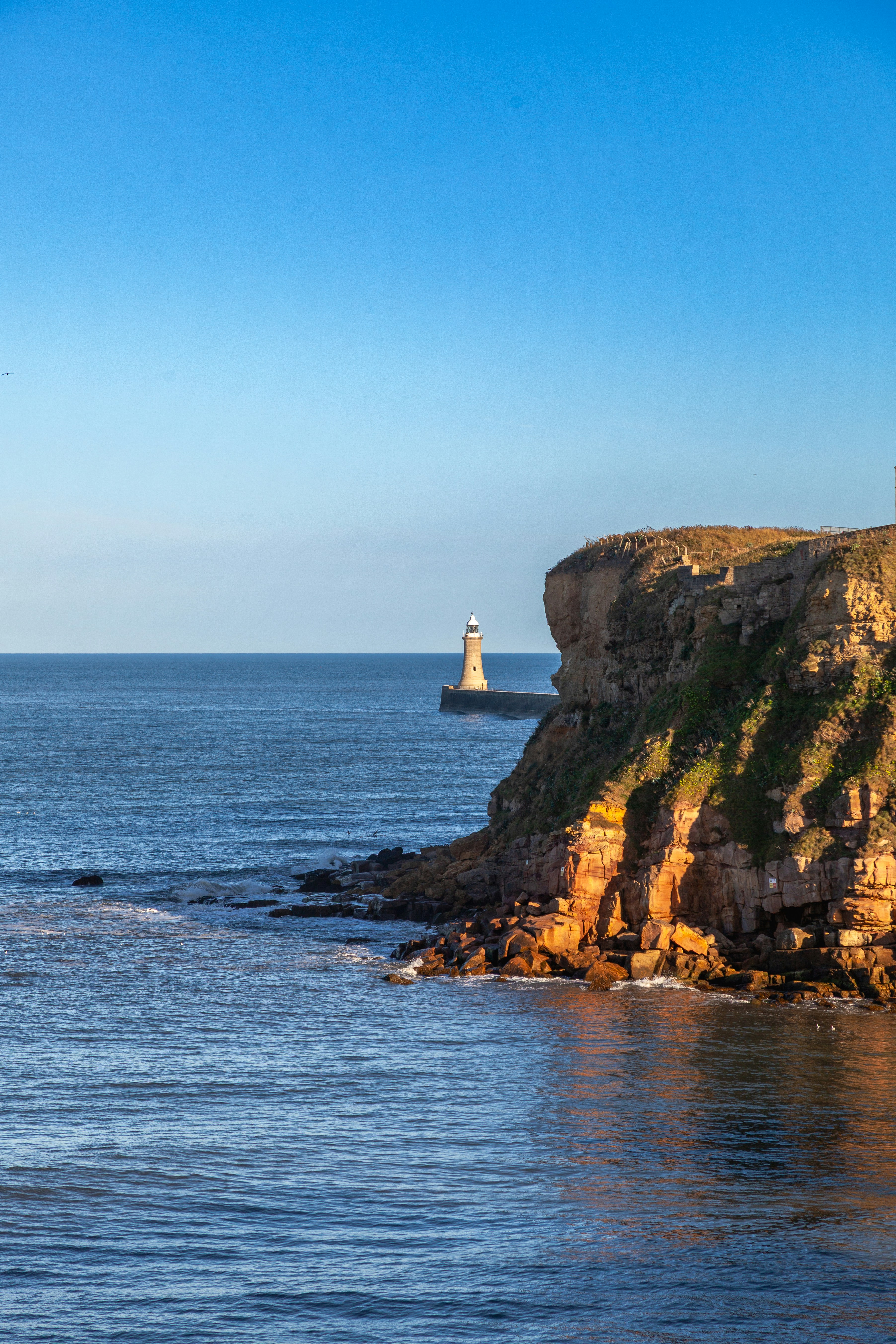 Lighthouse on a rocky cliff by the sea