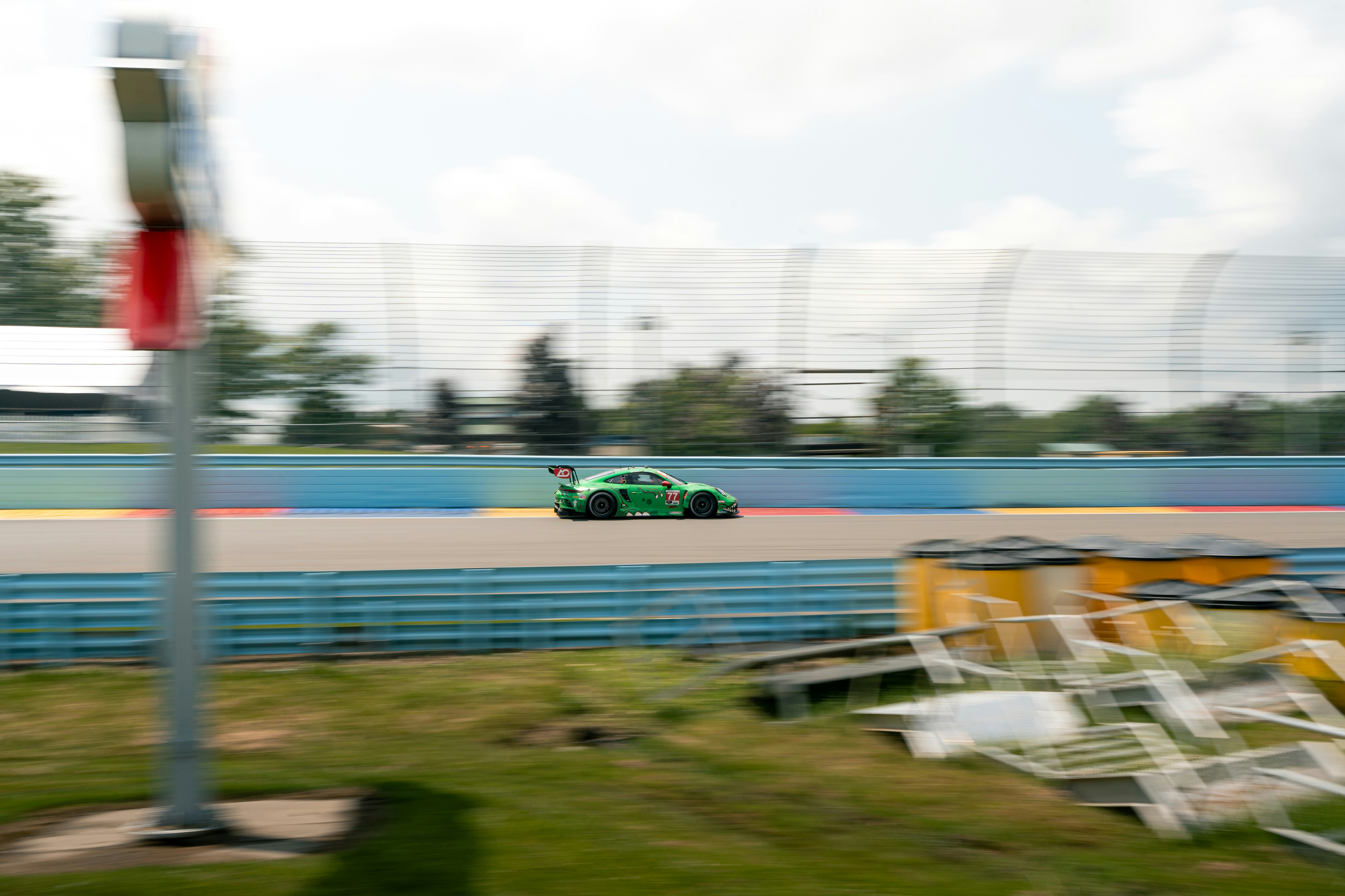 Green Streak on the Circuit: A Panned Moment of Velocity