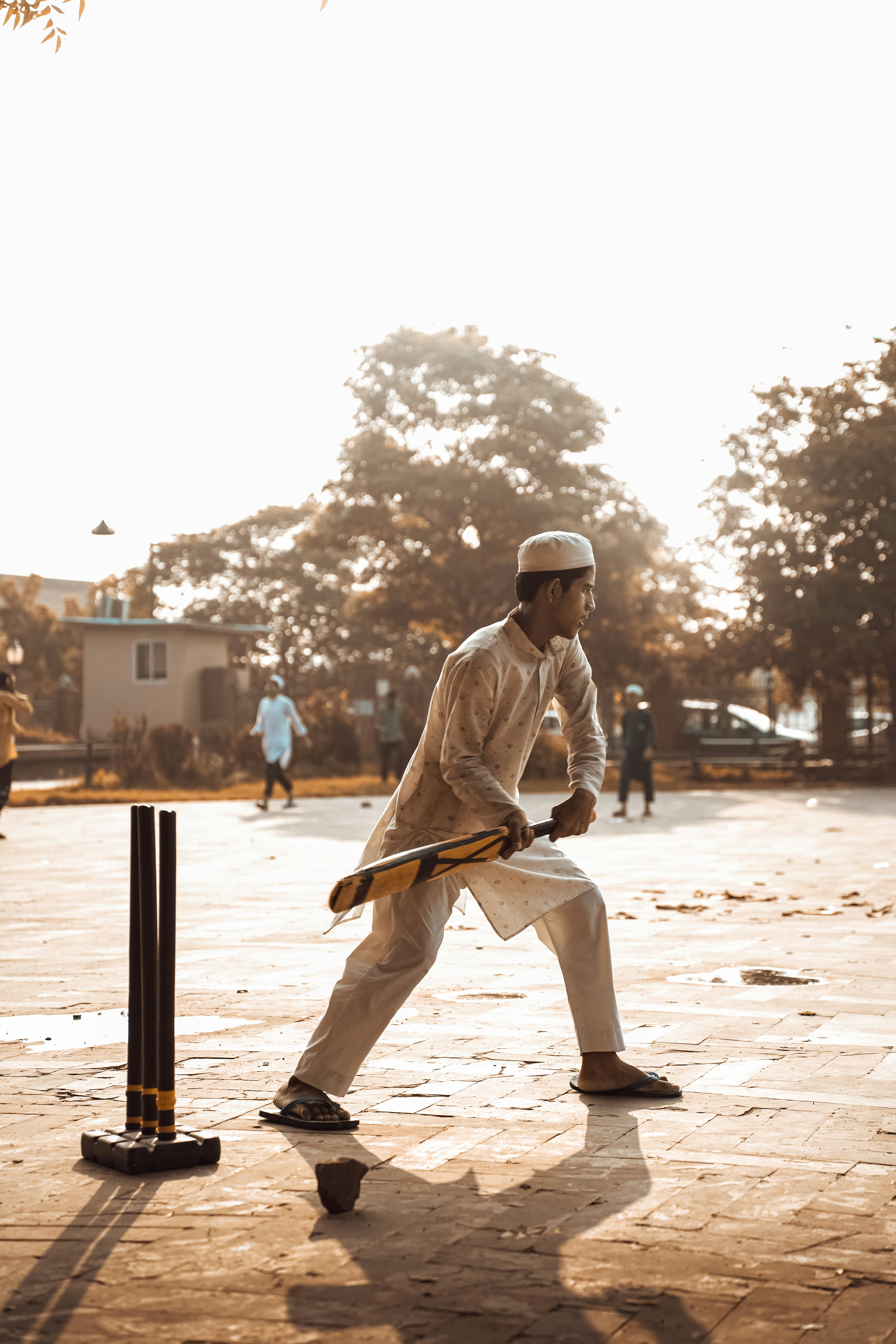 Man batting during a cricket game outdoors