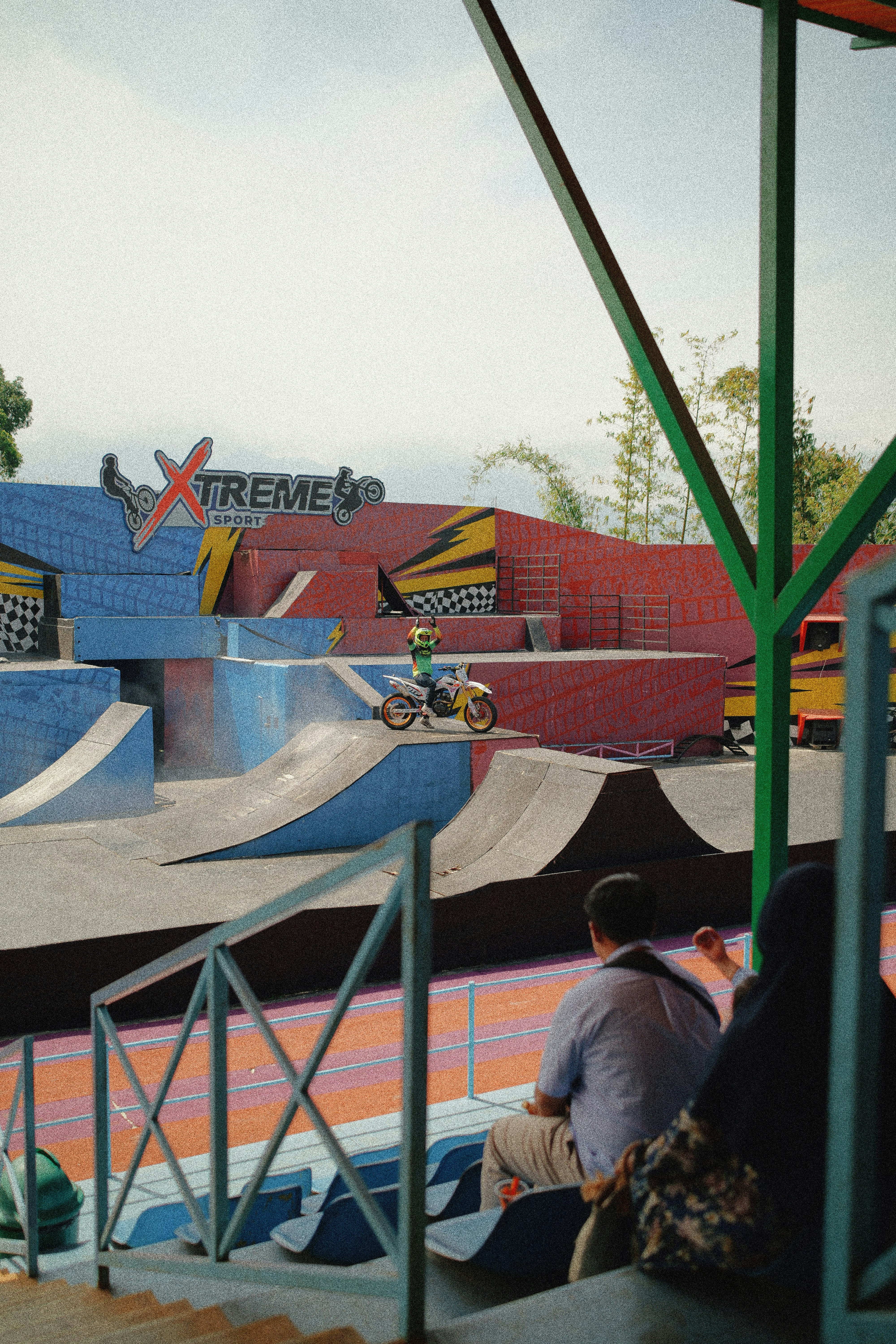 Motocross rider performs stunt on ramp