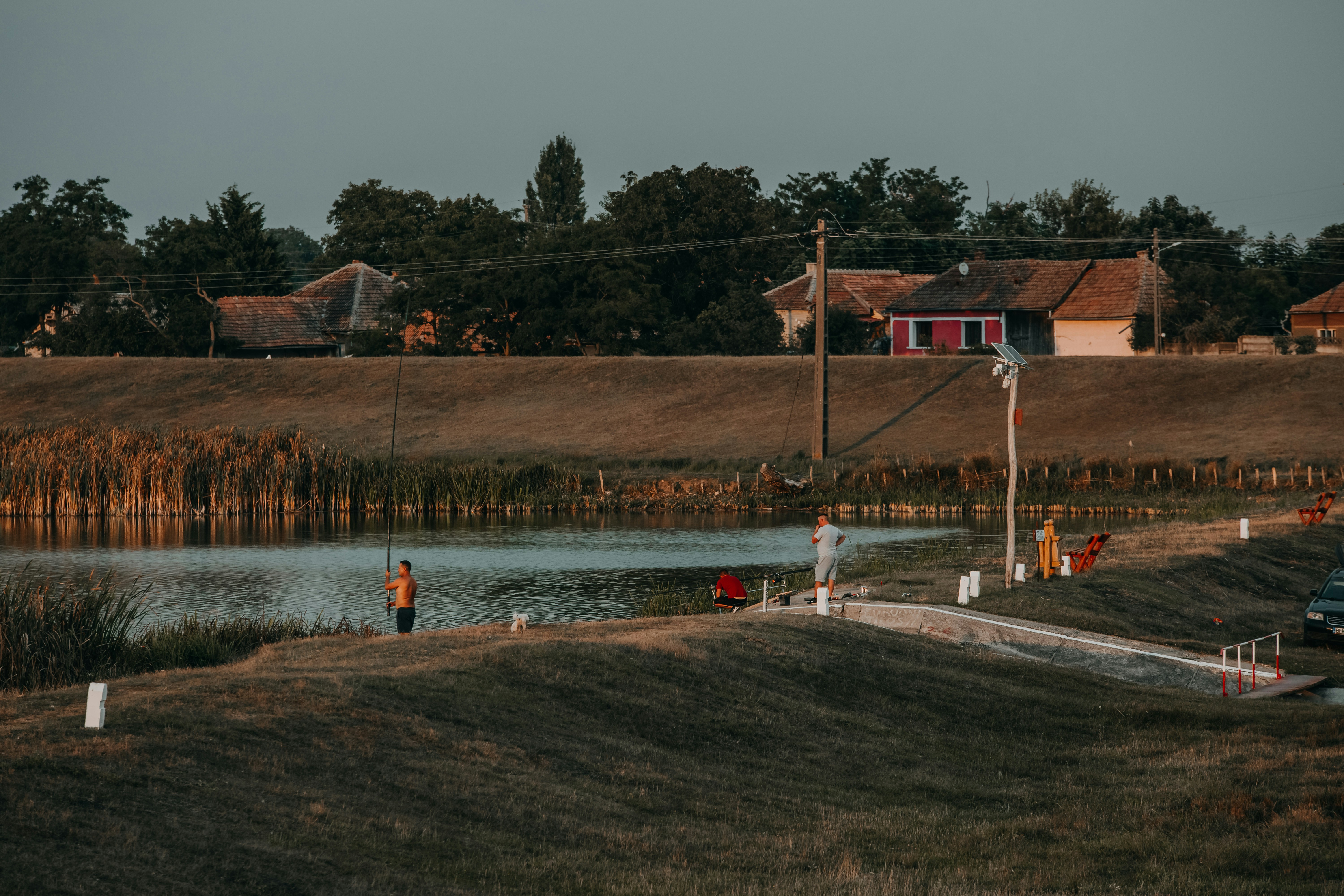 A rural landscape with houses and a body of water.