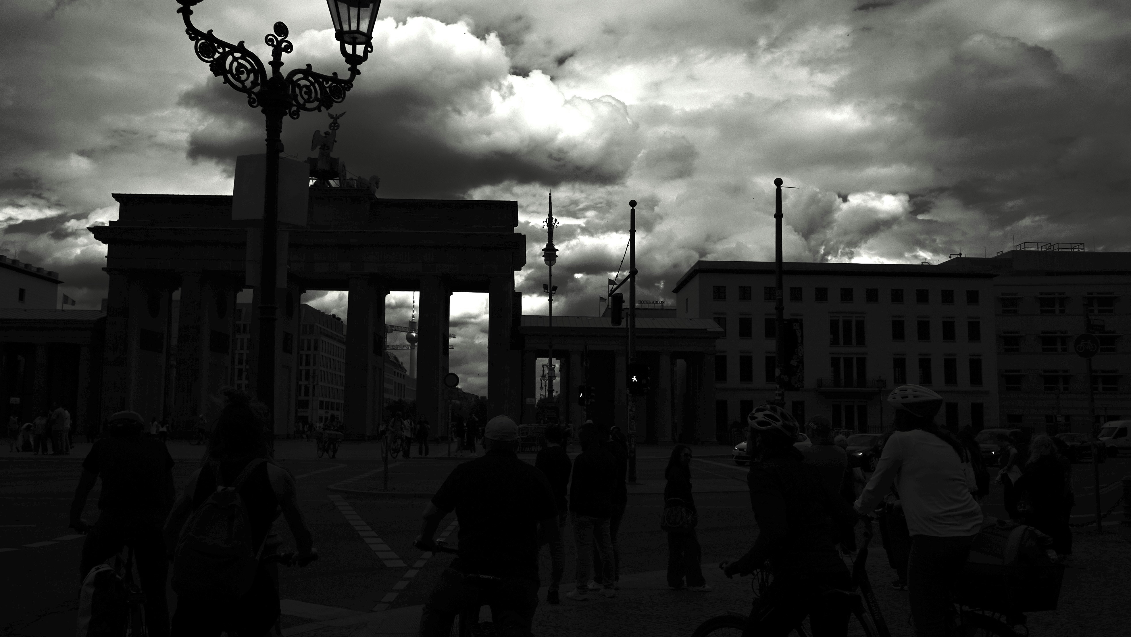 Shadows Over a City Gate: Silhouettes at a Historic Square