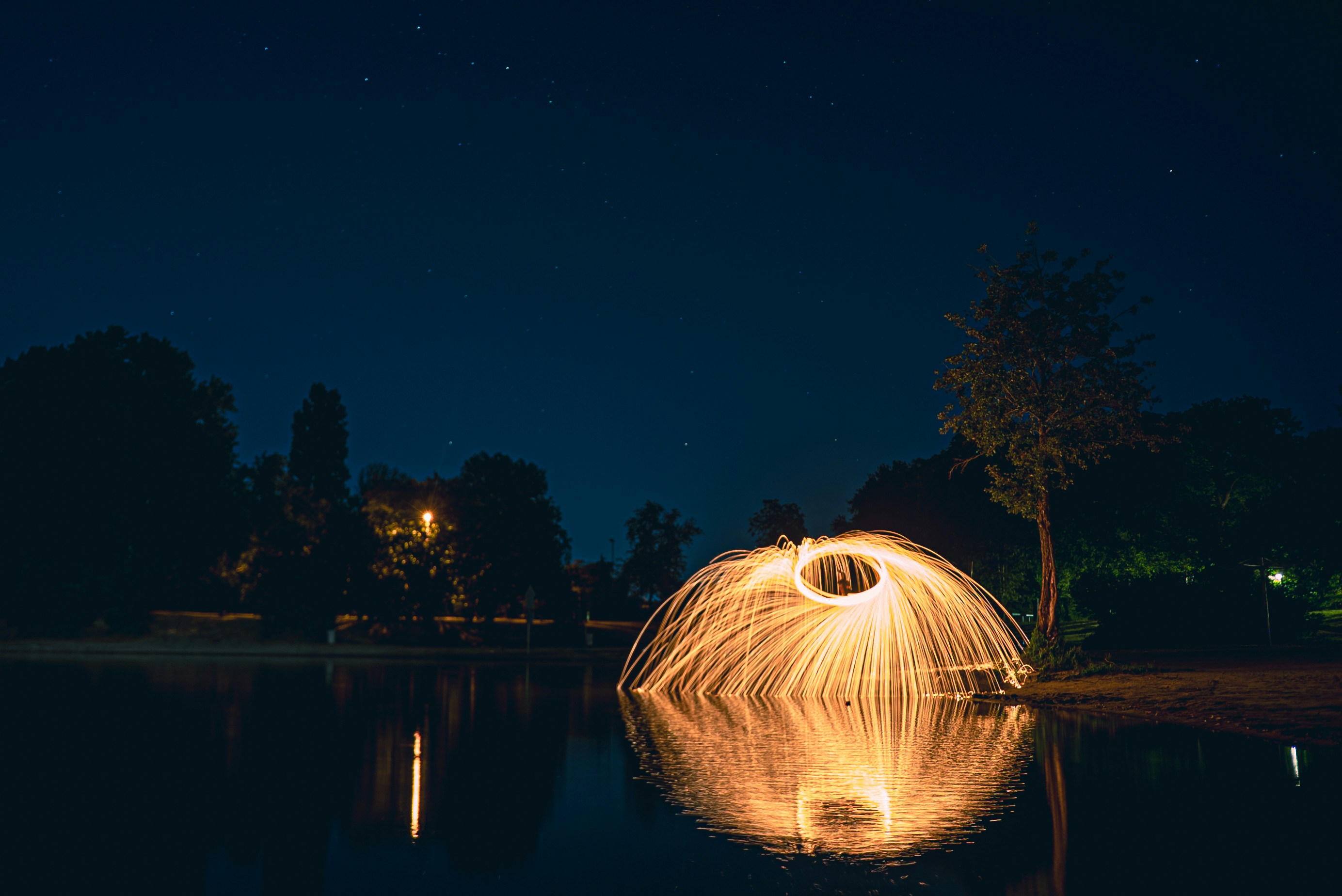 Firewheel Serenade: A Night Ring of Light on Still Water