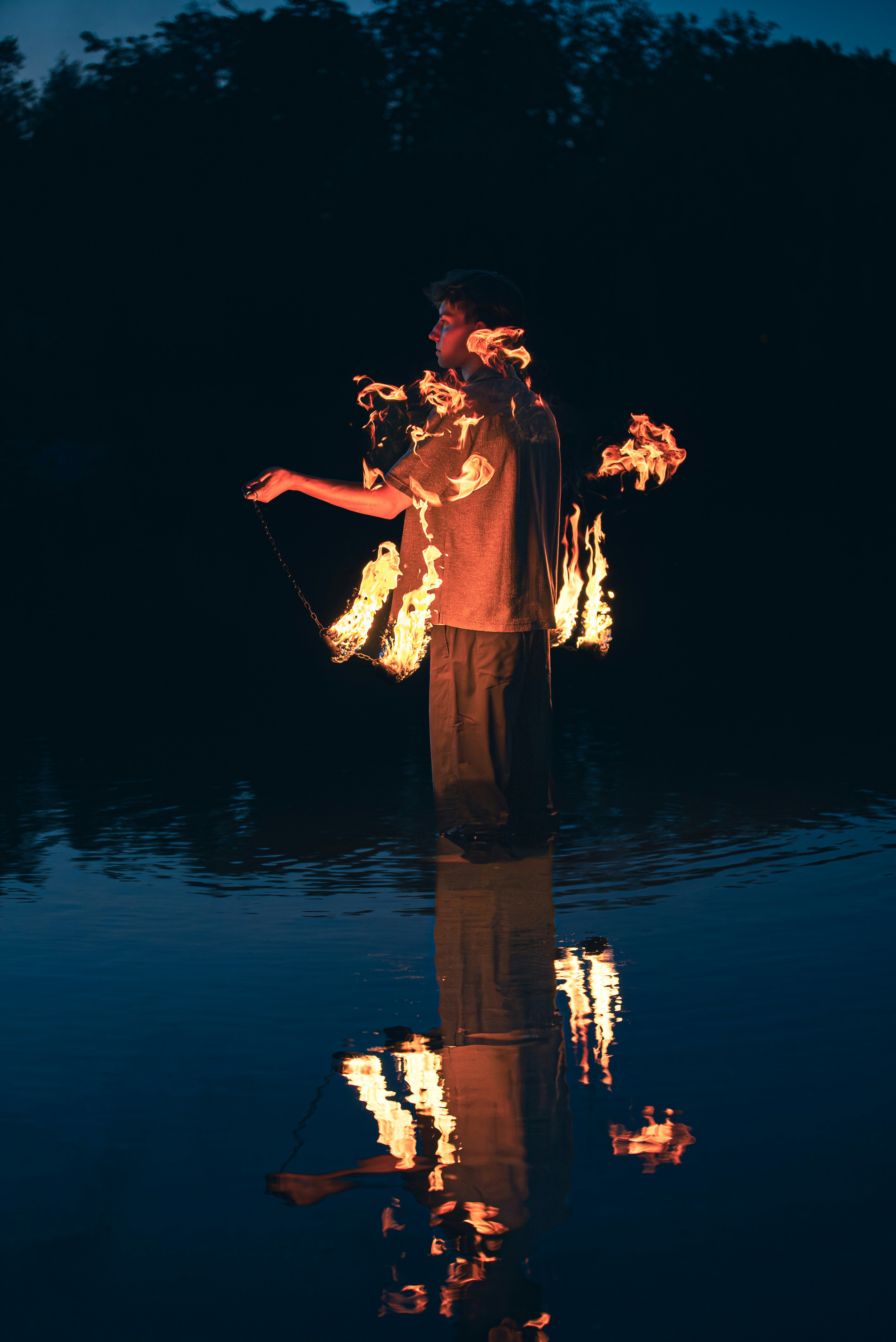 Man performing with fire by the water at night photo – Free Image on ...