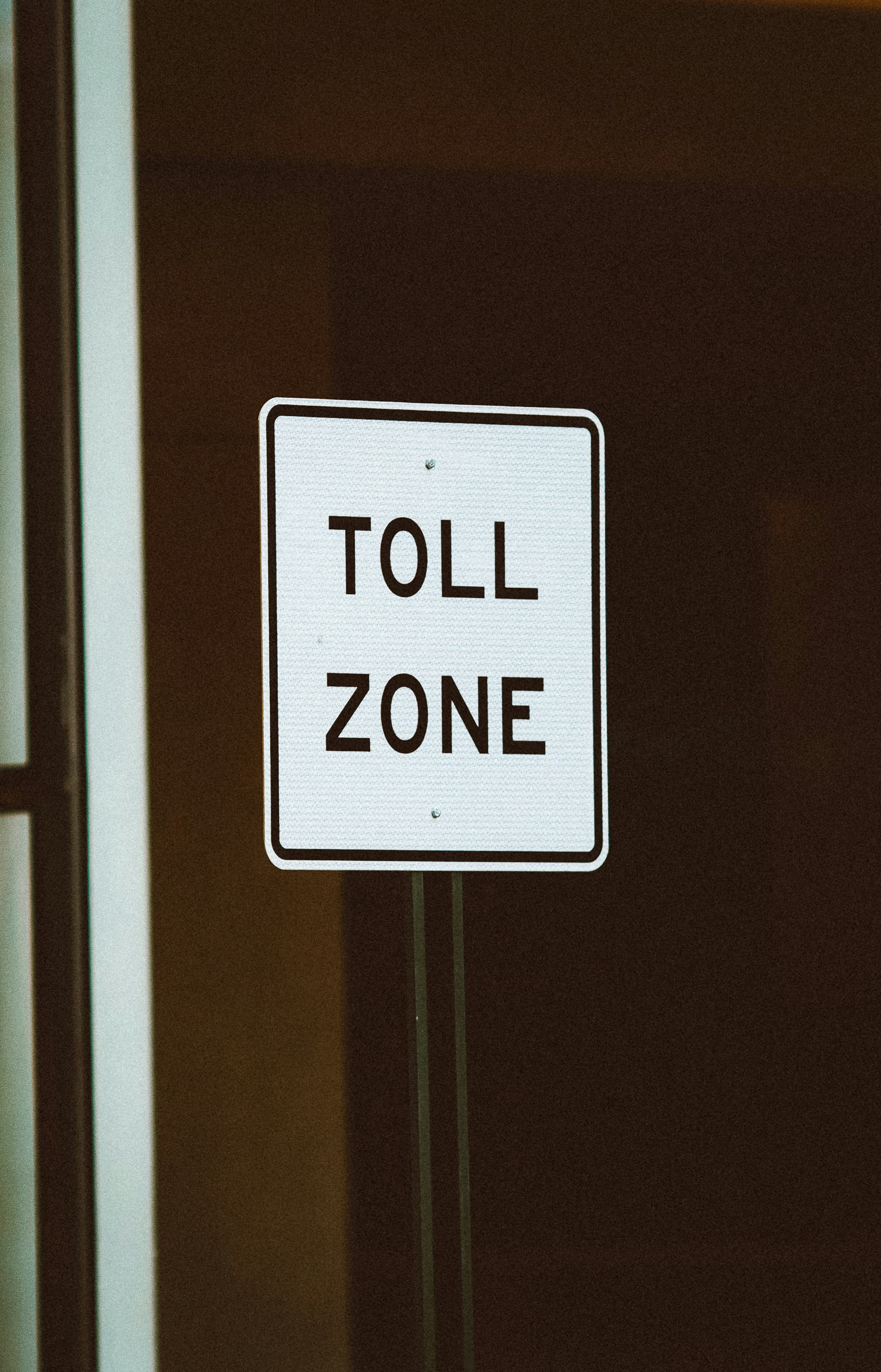 White sign with black text reading toll zone photo – Free Toll Image on ...