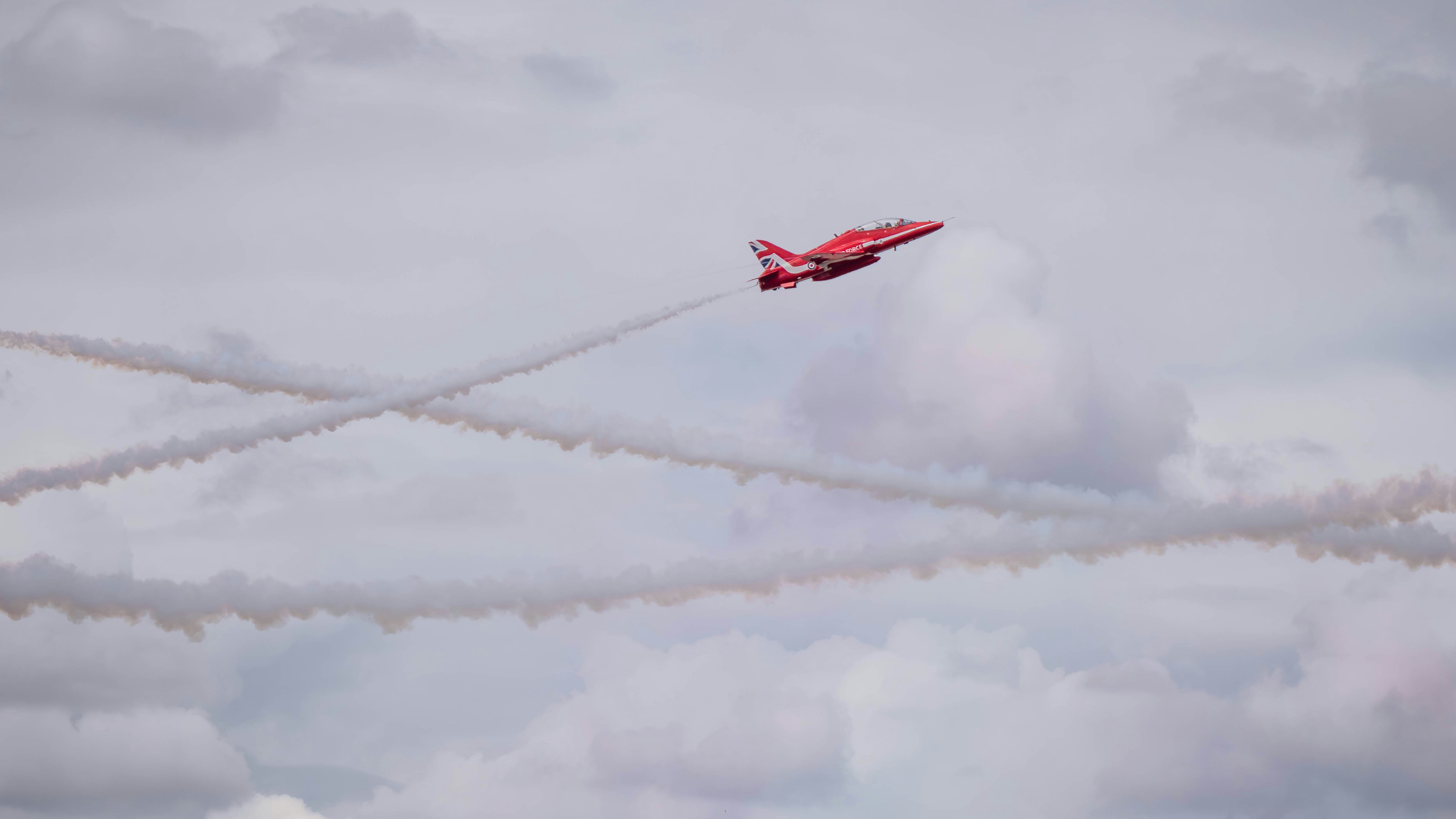 Crimson Aerobatic Jet Through Cloud Trails