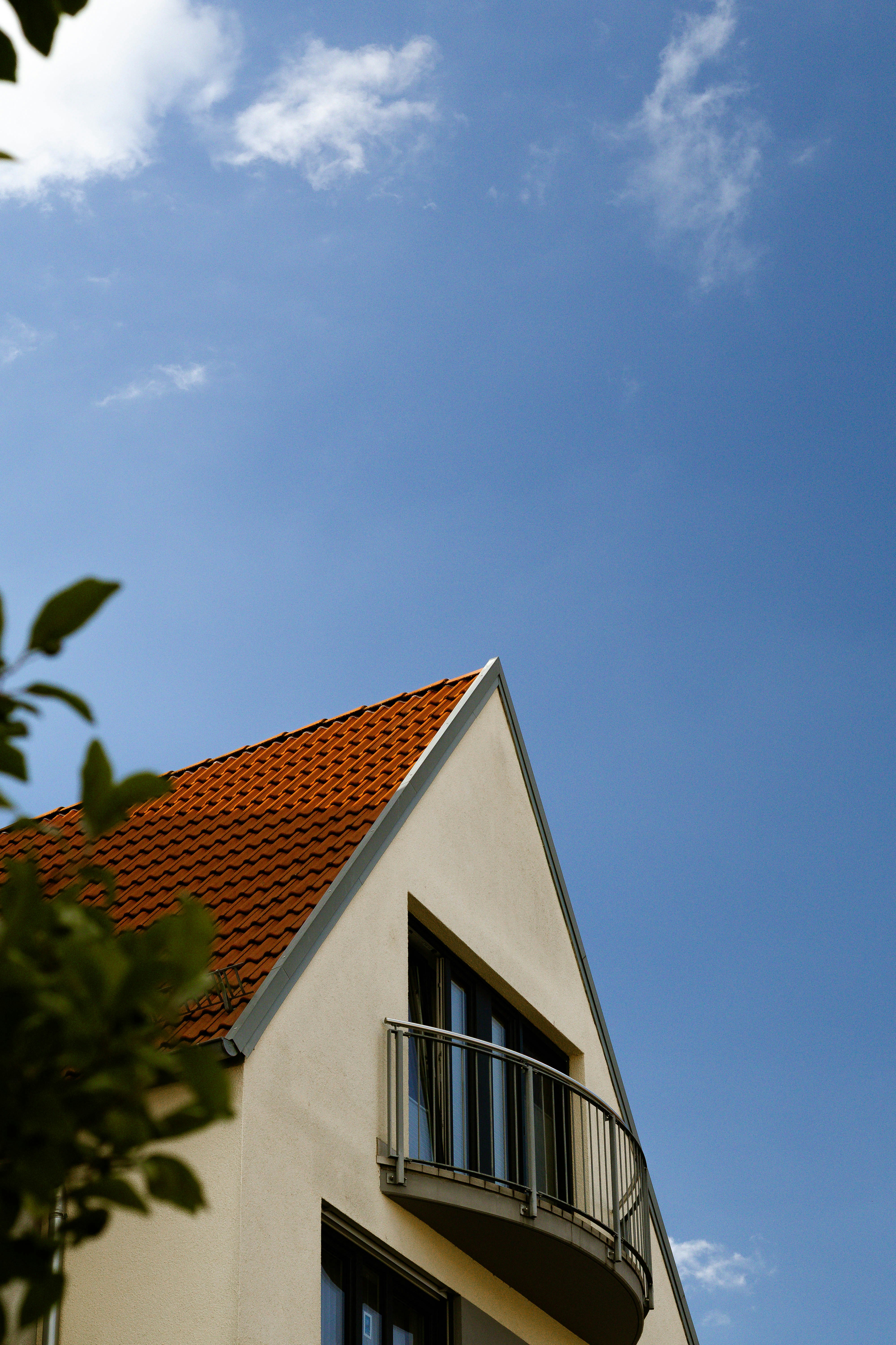 Modern house with balcony under blue sky